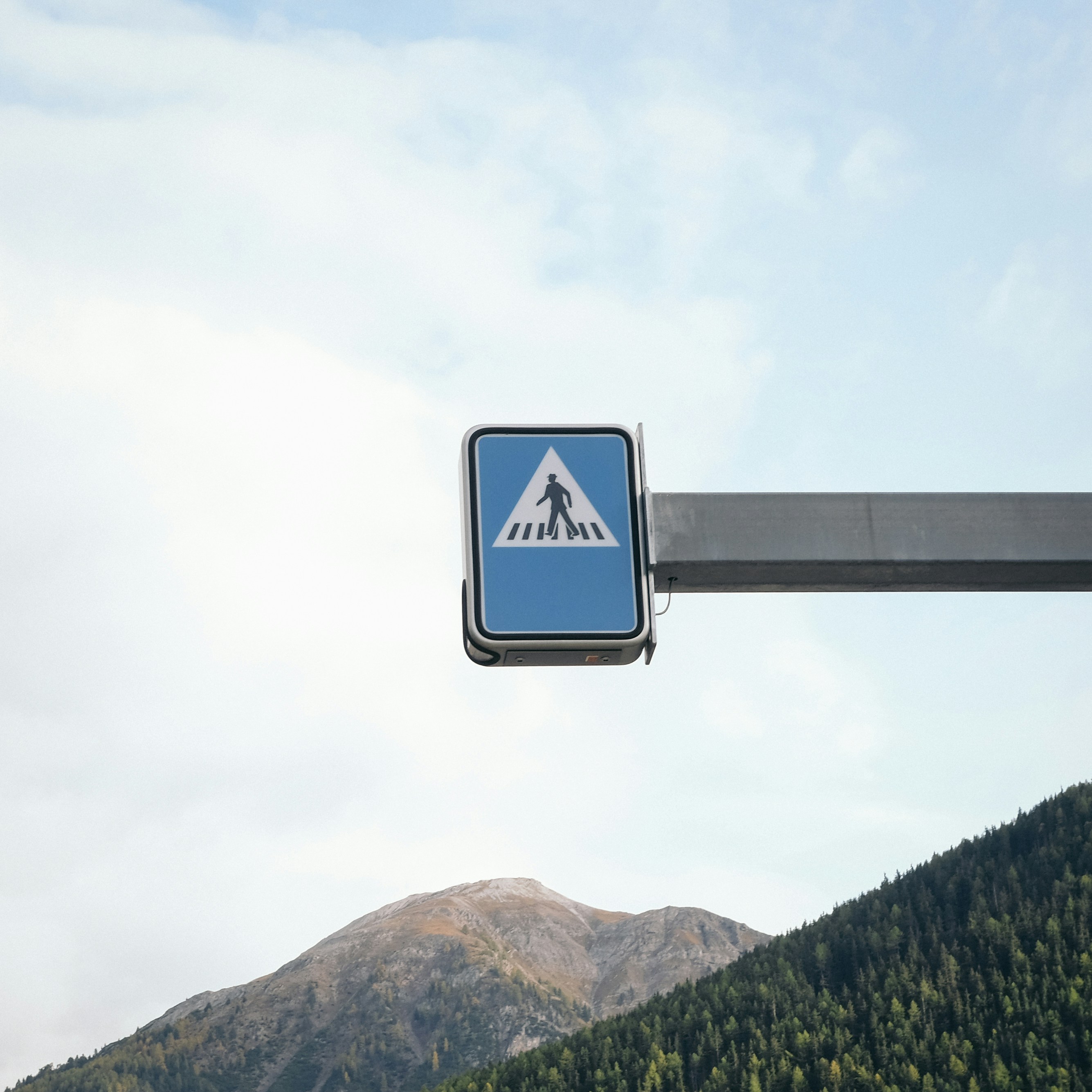 Pedestrian Crossing Sign Over a Mountain Ridge