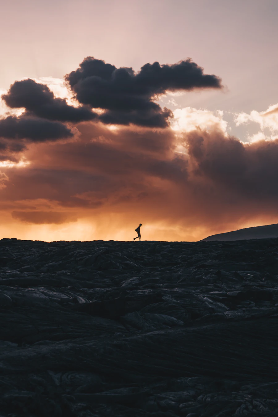 Walking thru Kalapana Lava Fields Volcano to the lava viewing point. | landscape photo of person walking on horizon