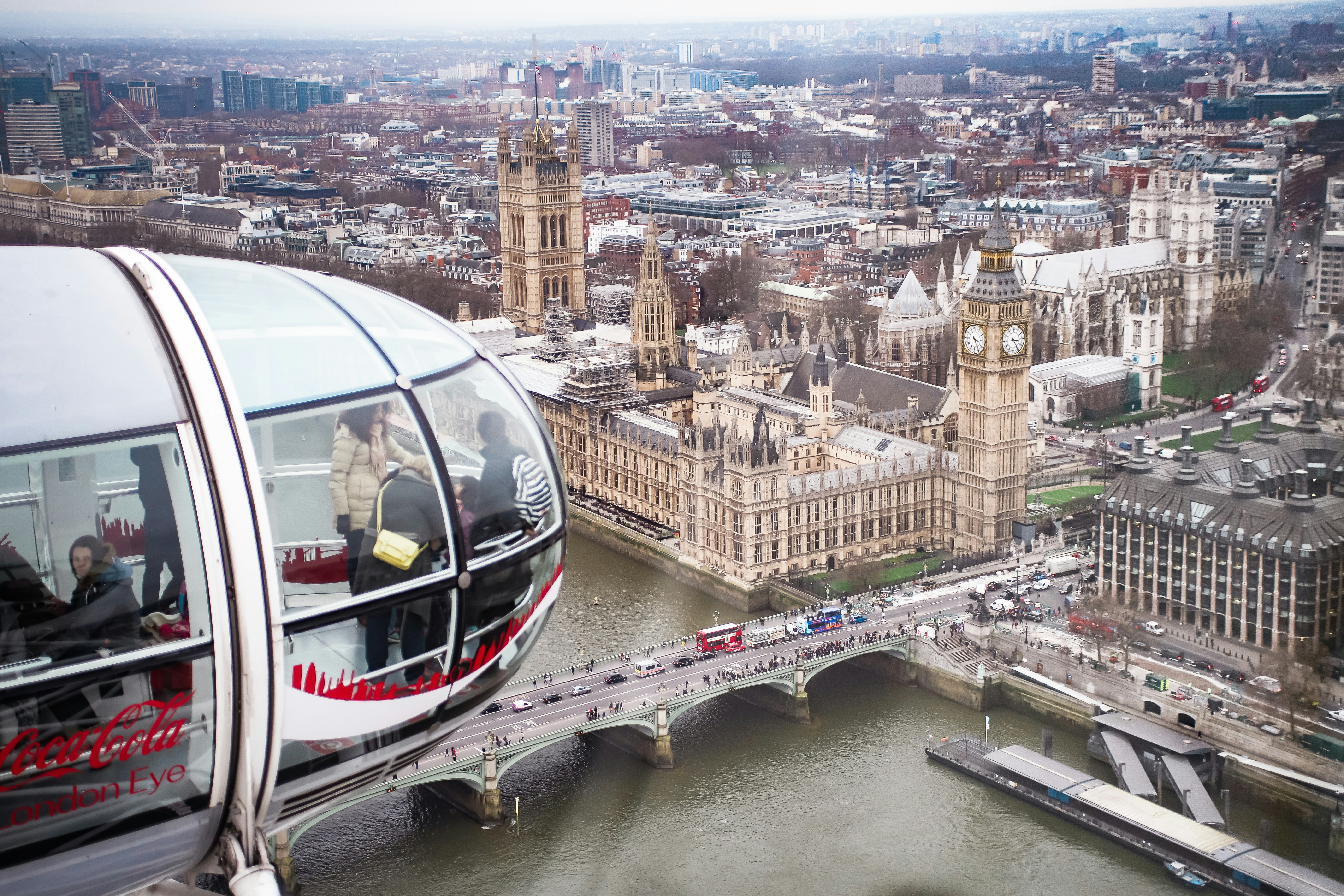 Westminister | a cable car going over a bridge over a river