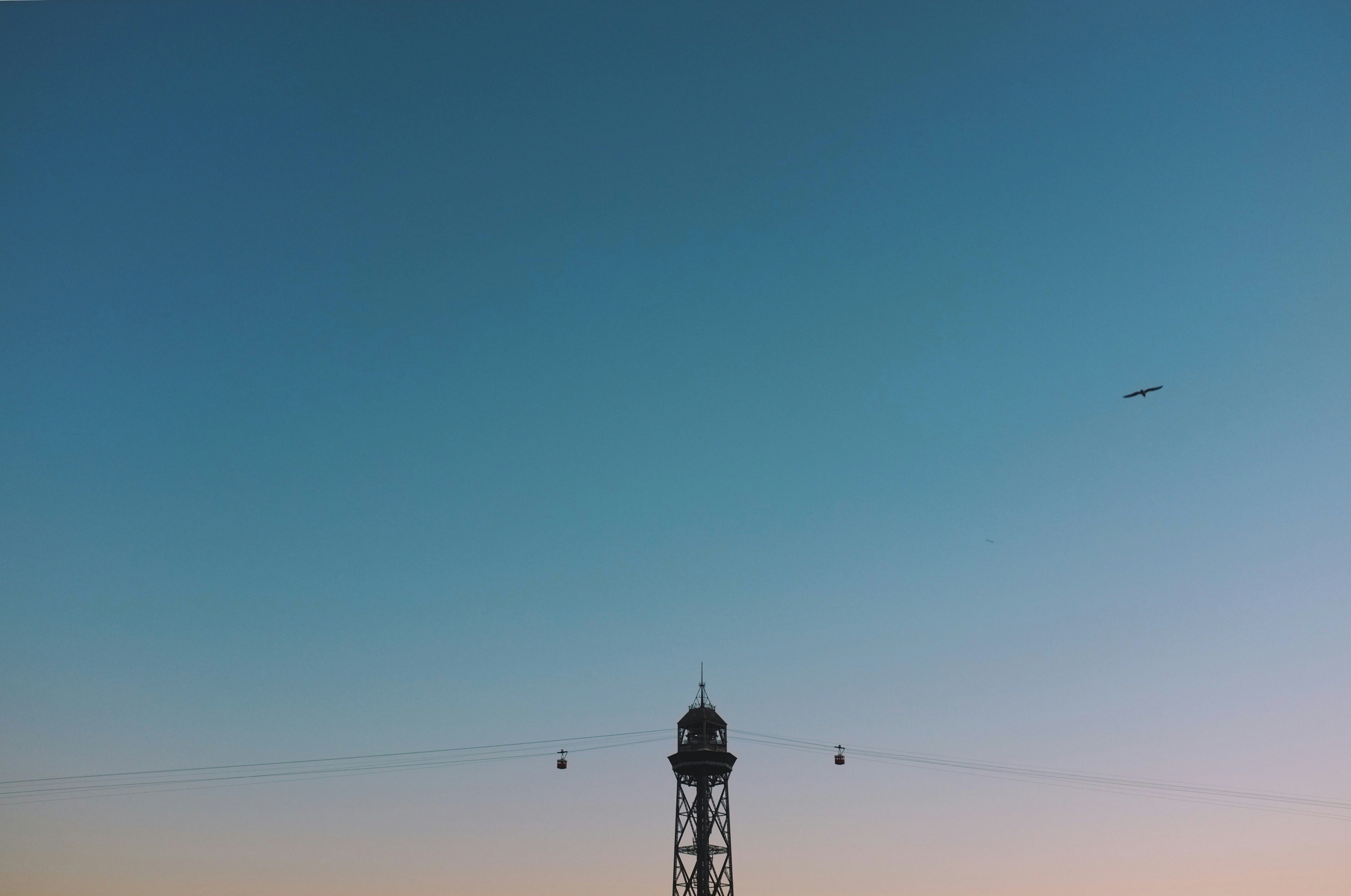 Dusk Lattice: a lone cable-tower framed by a fading sky