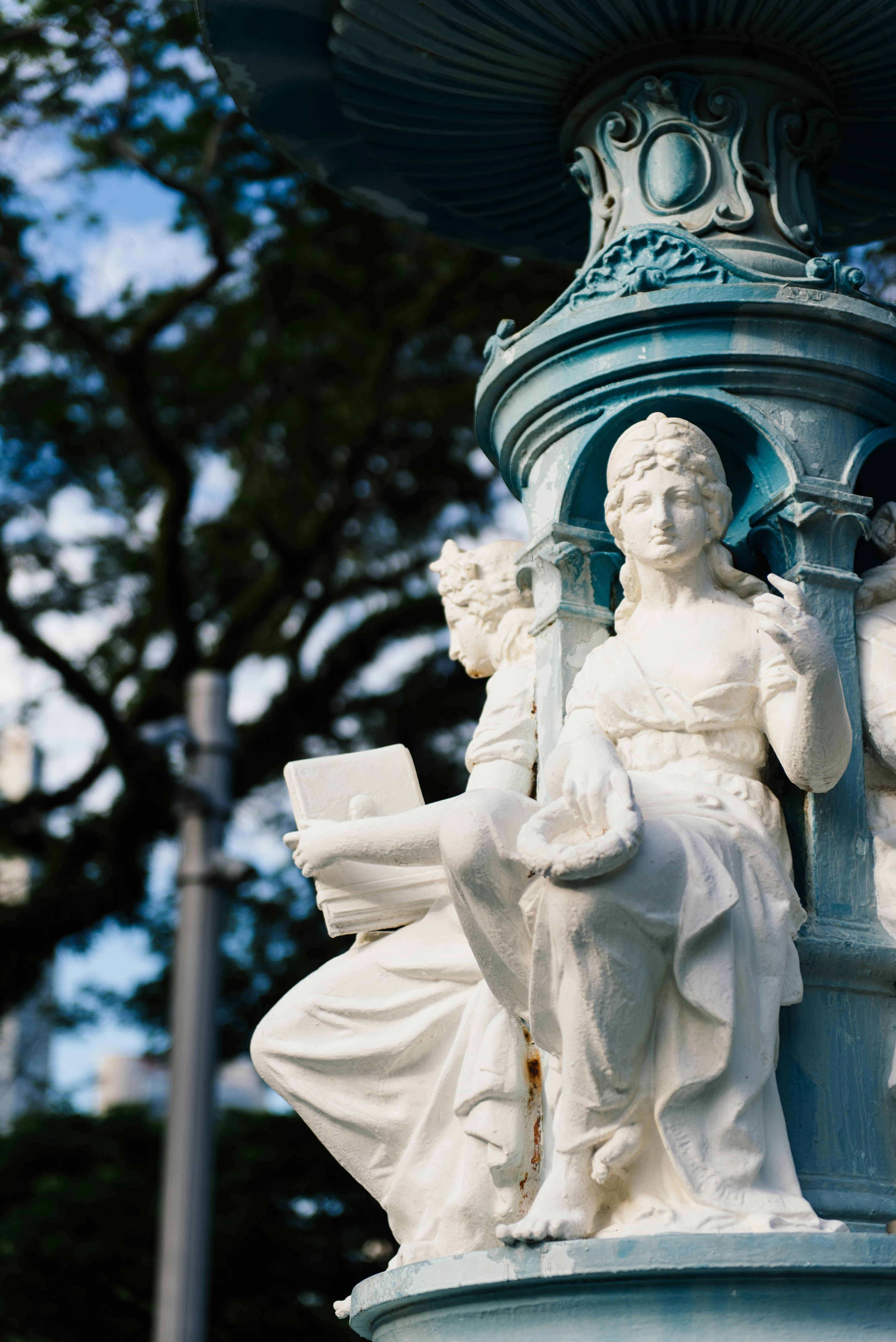 Patina Sentinel: Teal-Patina Statues Guarding an Ornate Lantern