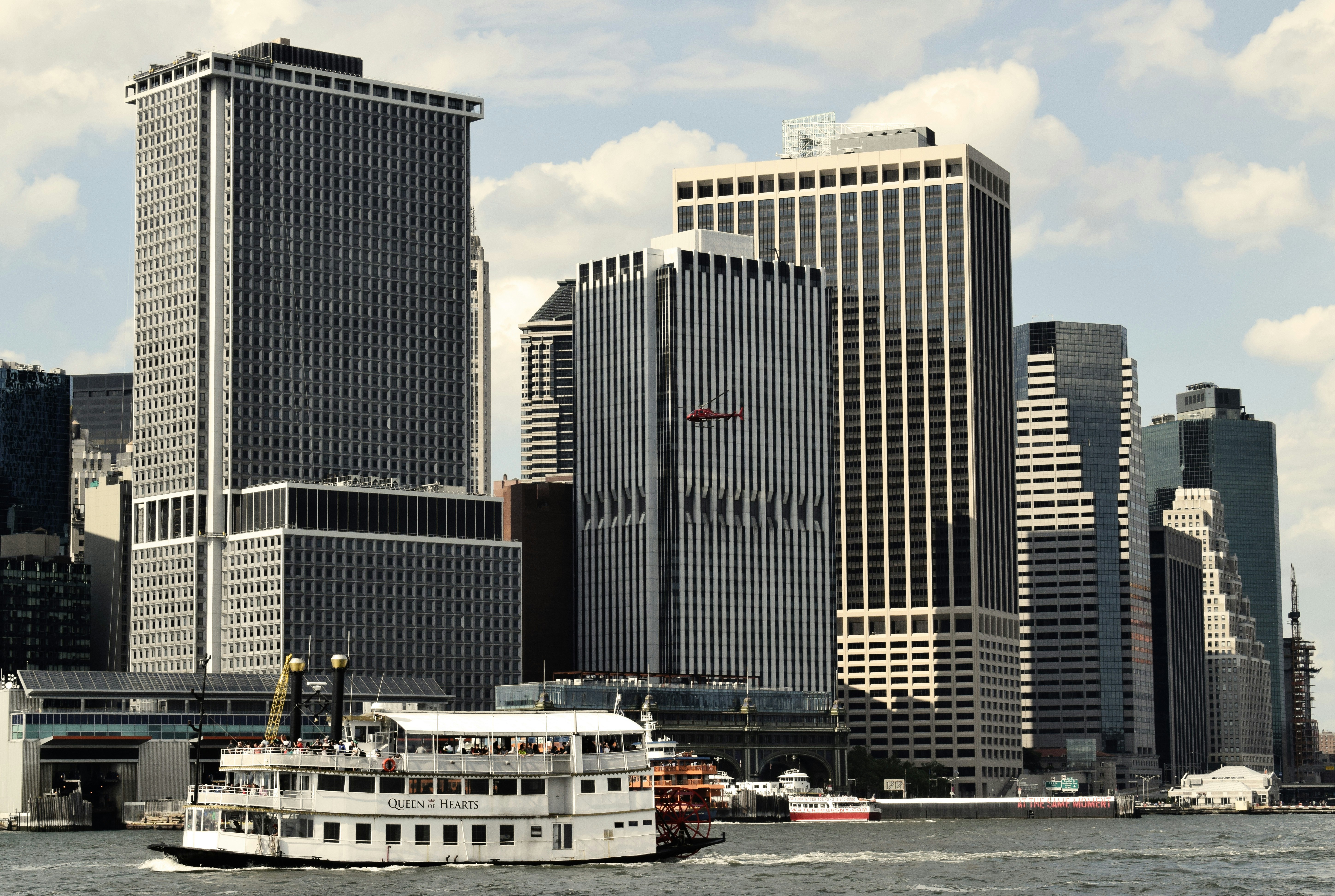 White Ferry at the Edge of a Glass-Giant Skyline