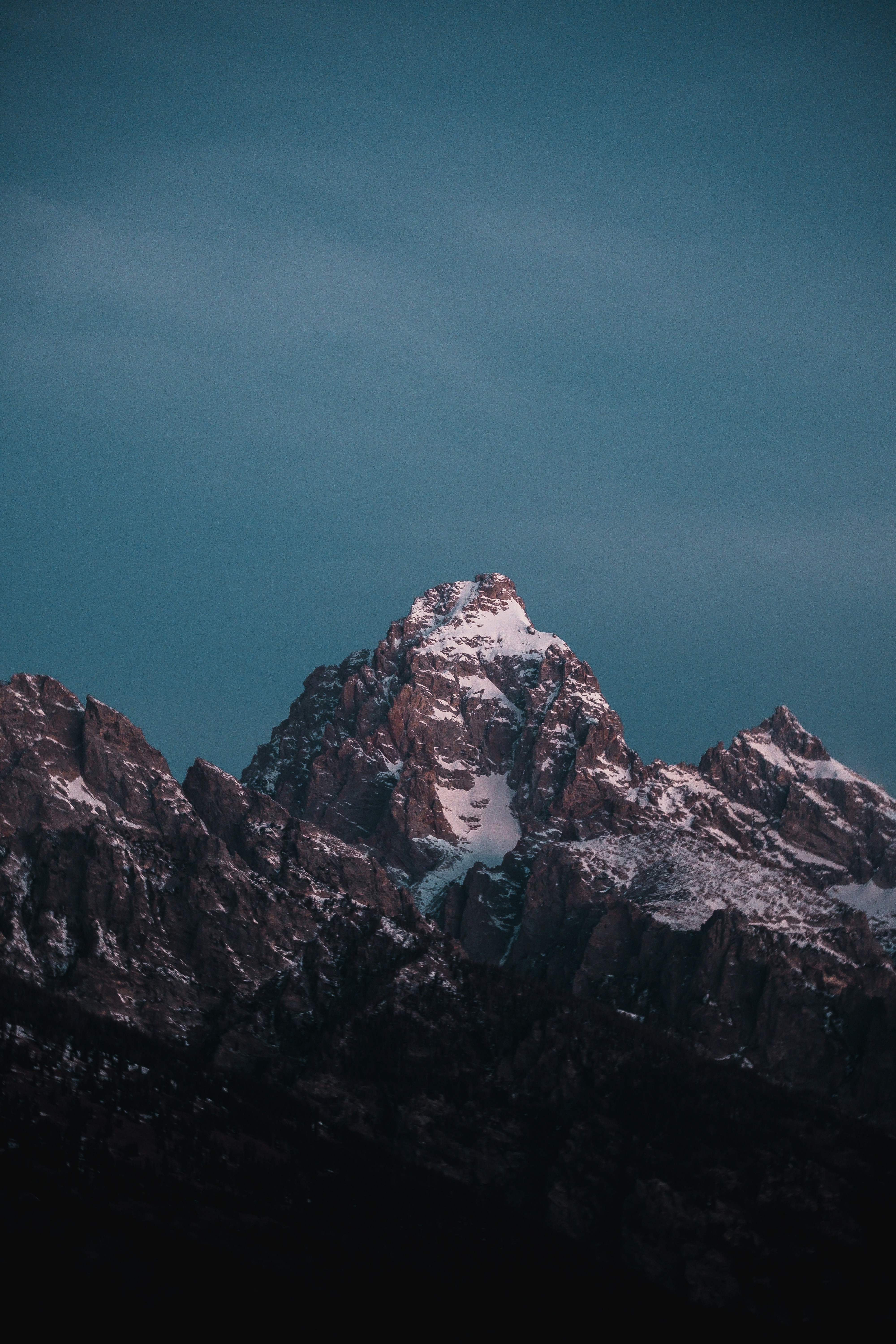 5:30 AM, freezing temperatures, and coffee that was too hot. Instead of using a wide angle to capture as much of the mountains as I could, I opted in for a super telephoto to capture the peak. The stoic mountains added to the quiet that blanketed the valley. The occasional call from the Elk herds behind me were the only noise that would interrupt the quiet. | mountain covered with snow