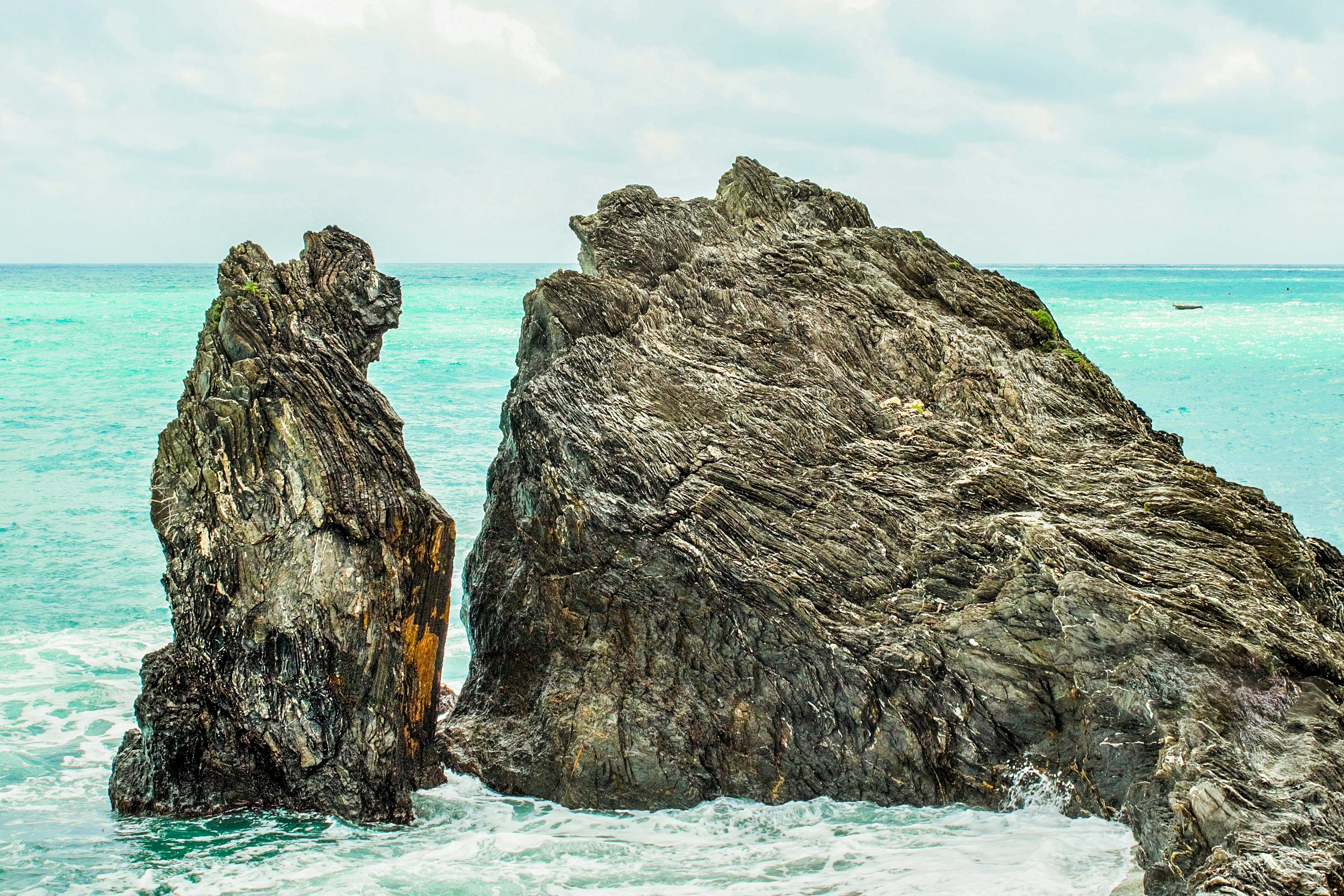 Twin Sea Sentinels: Jagged Rocks Rise from Turquoise Waters