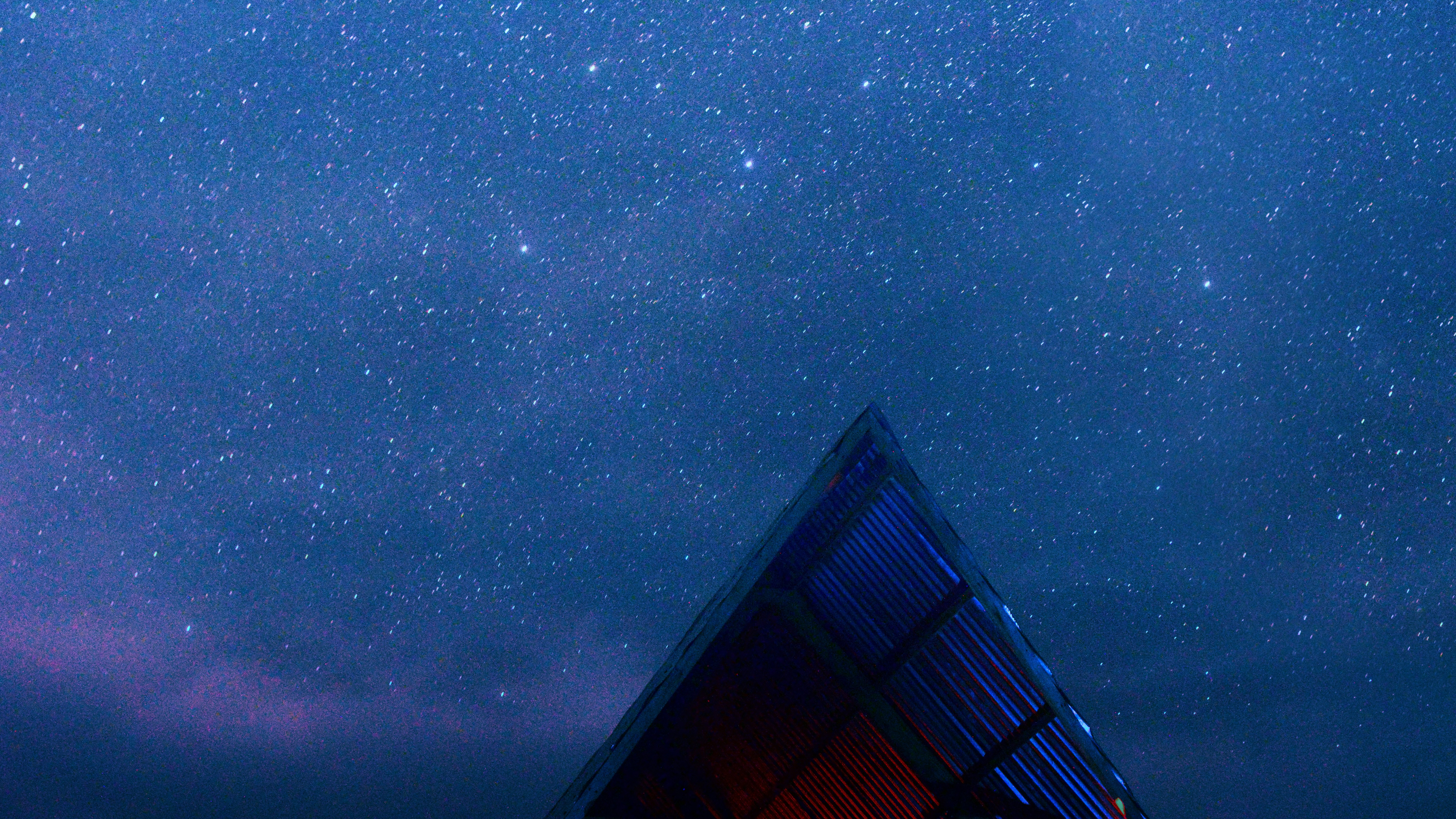 Leaning Roofline Beneath a Star-Pinned Night Sky