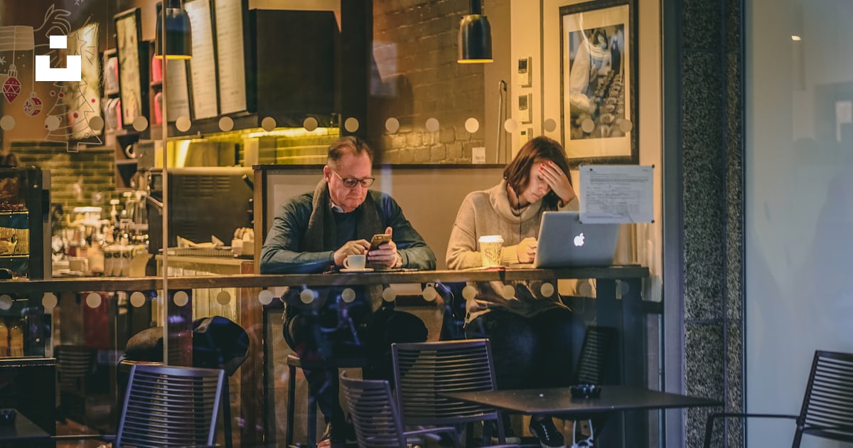 레스토랑에서 은색 Macbook 앞에 있는 여자 옆에 앉아 스마트폰을 들고 있는 남자 사진 Unsplash의 무료 카페 이미지