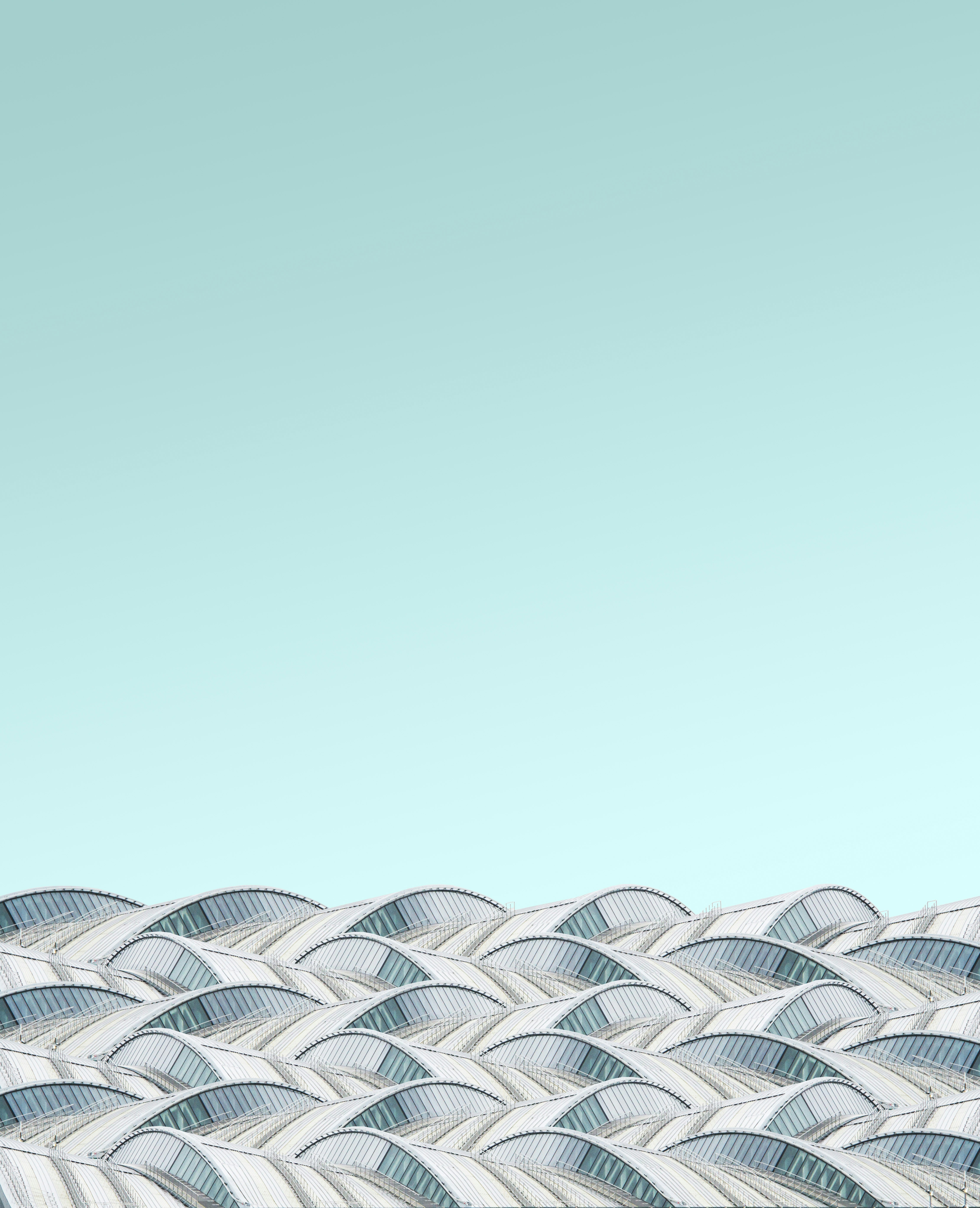 Intricate architectural design featuring a series of wave-like structures against a soft gradient background.