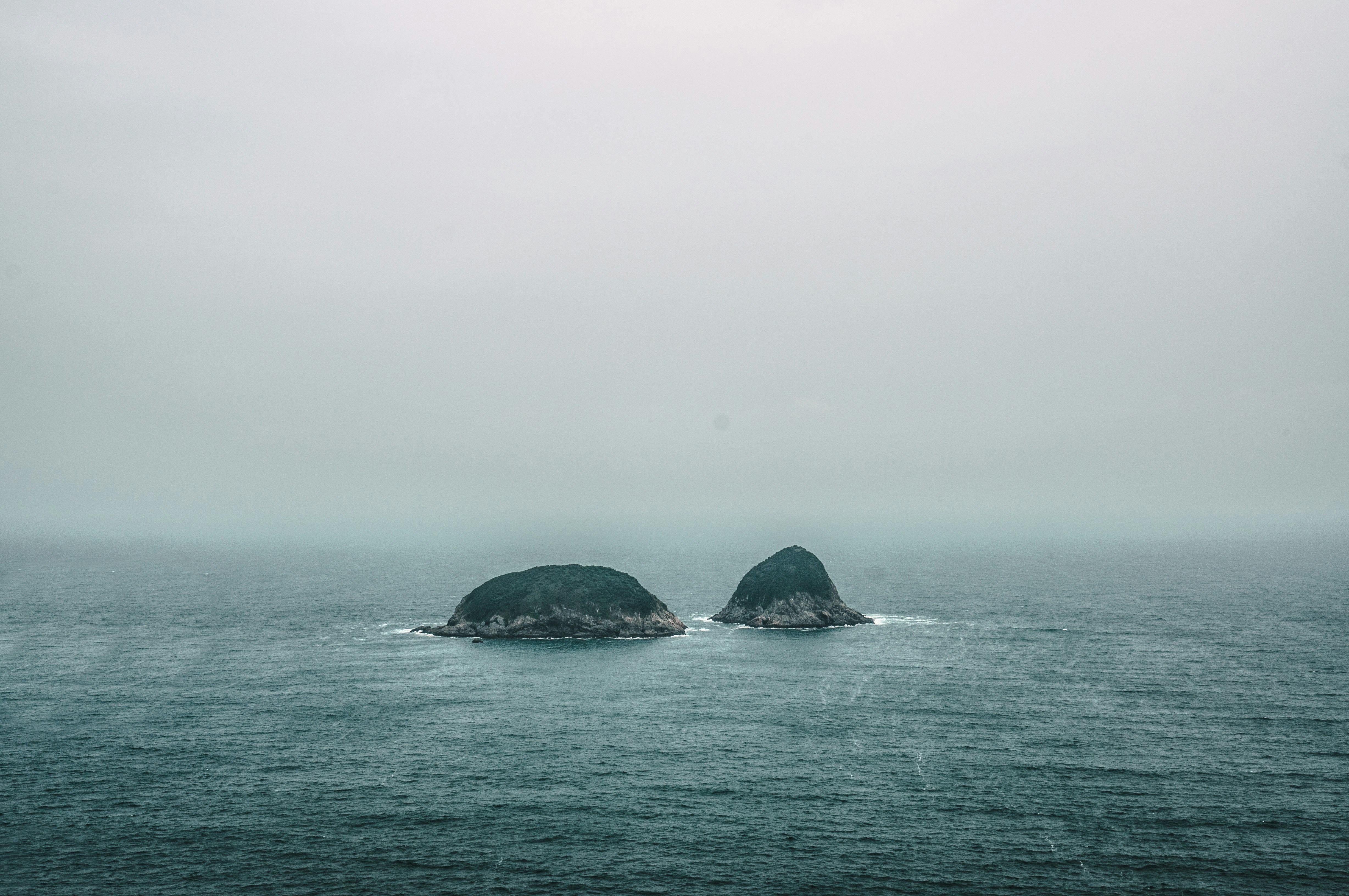 Two gray rock formations on the middle of sea at daytime photo – Free ...