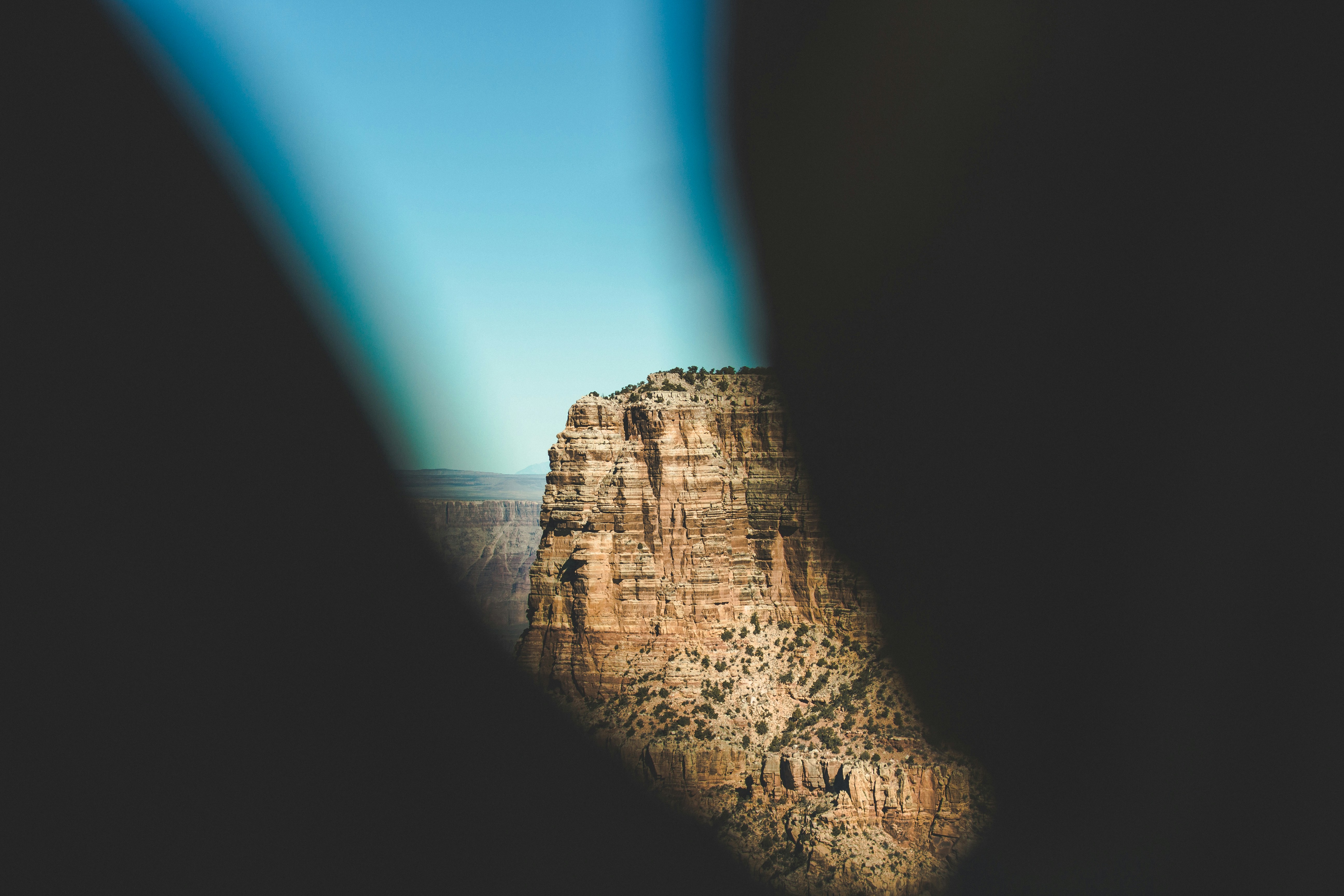 Framed Canyon: A Desert Cliff Emerges Between Shadow and Sky