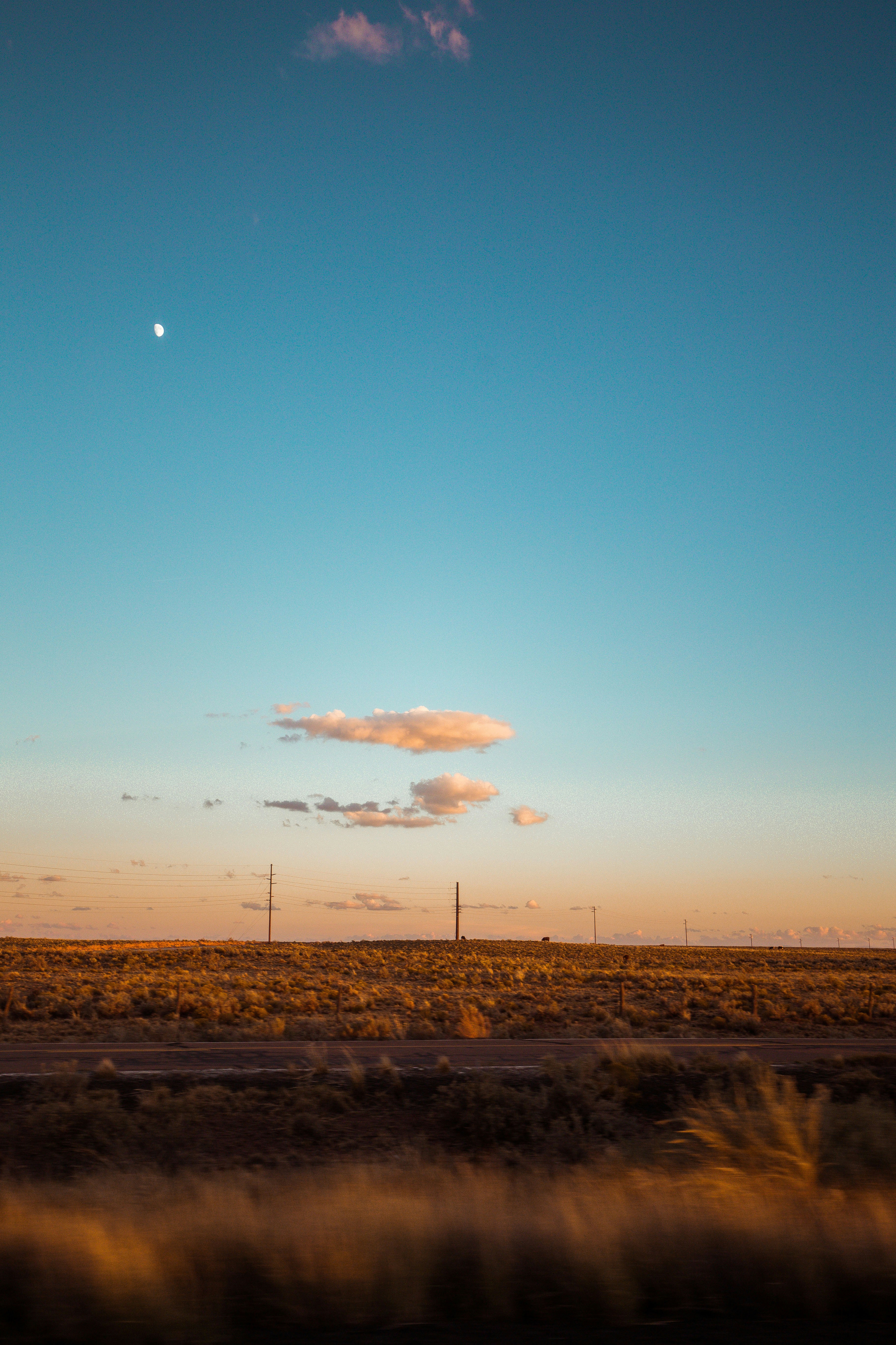 Lone Moon Over the Quiet Desert Horizon at Dusk