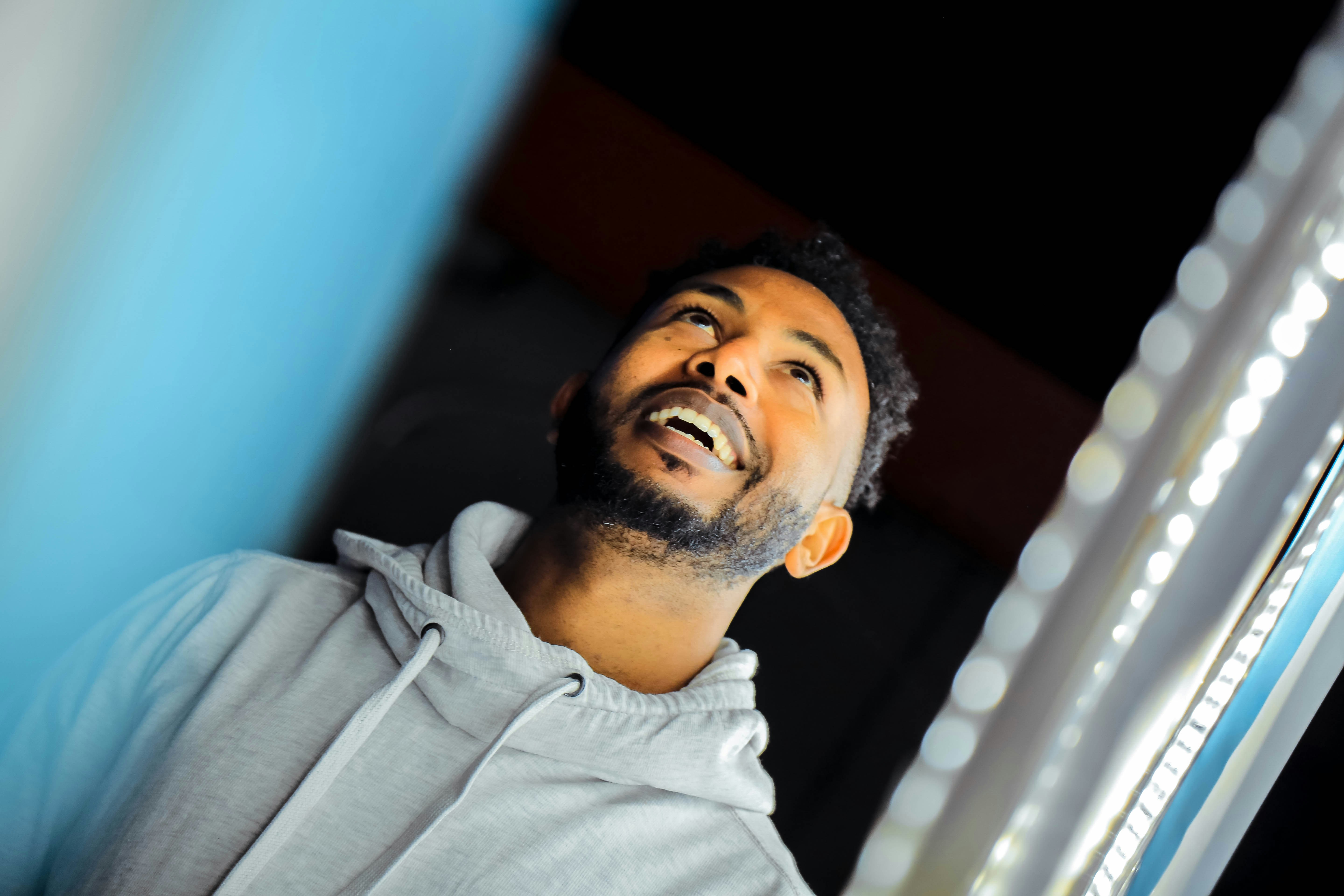 Blue Arch Portrait: A Warm Smile Under Neon Tubes