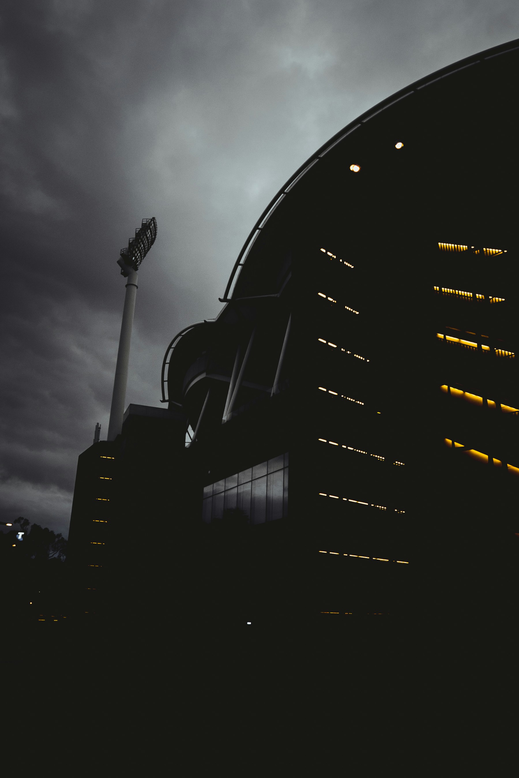 Luminous Stripes on a Curved Stadium at Dusk