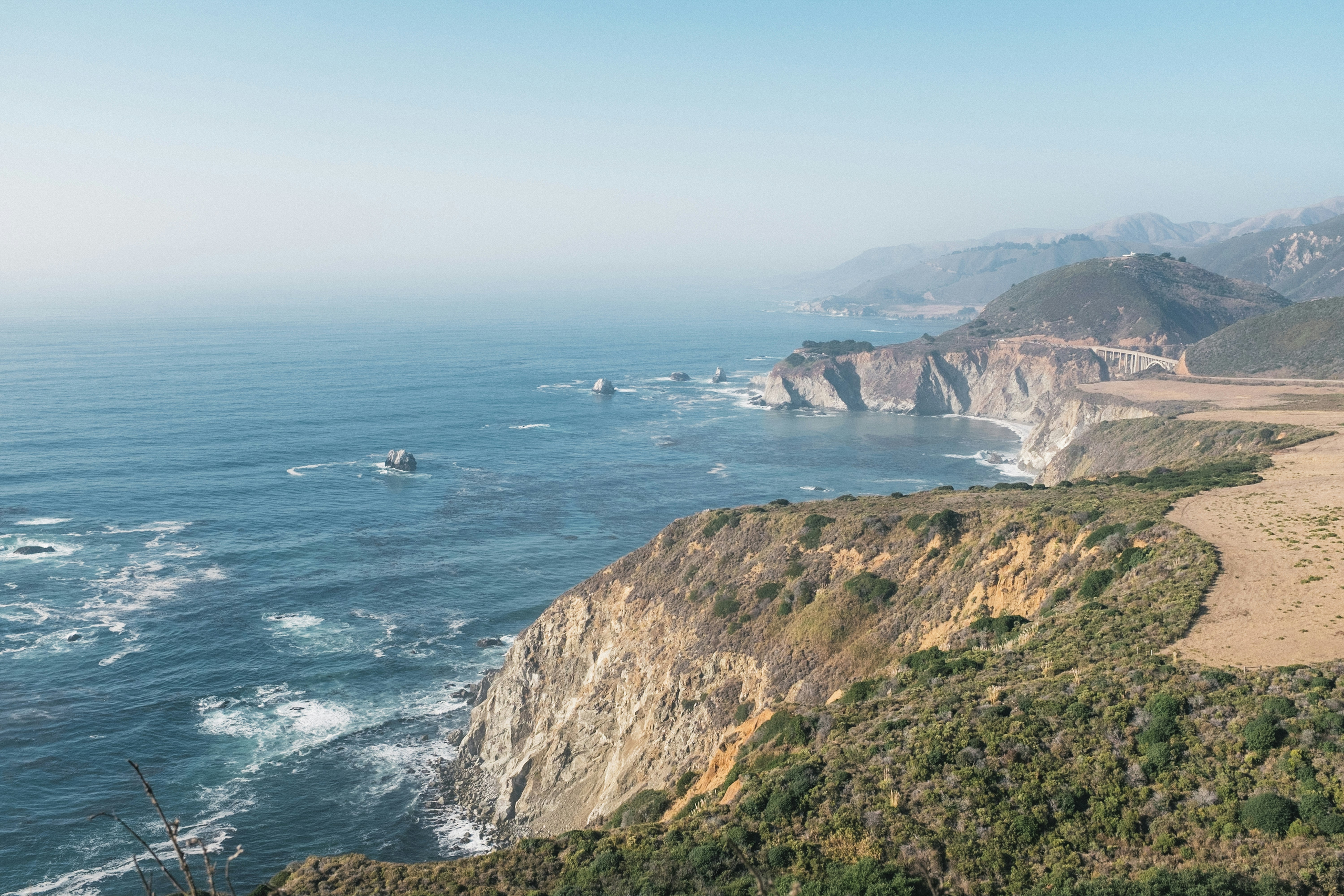 Cliff overlooking sea under cloudy sky at daytime photo – Free Coast ...