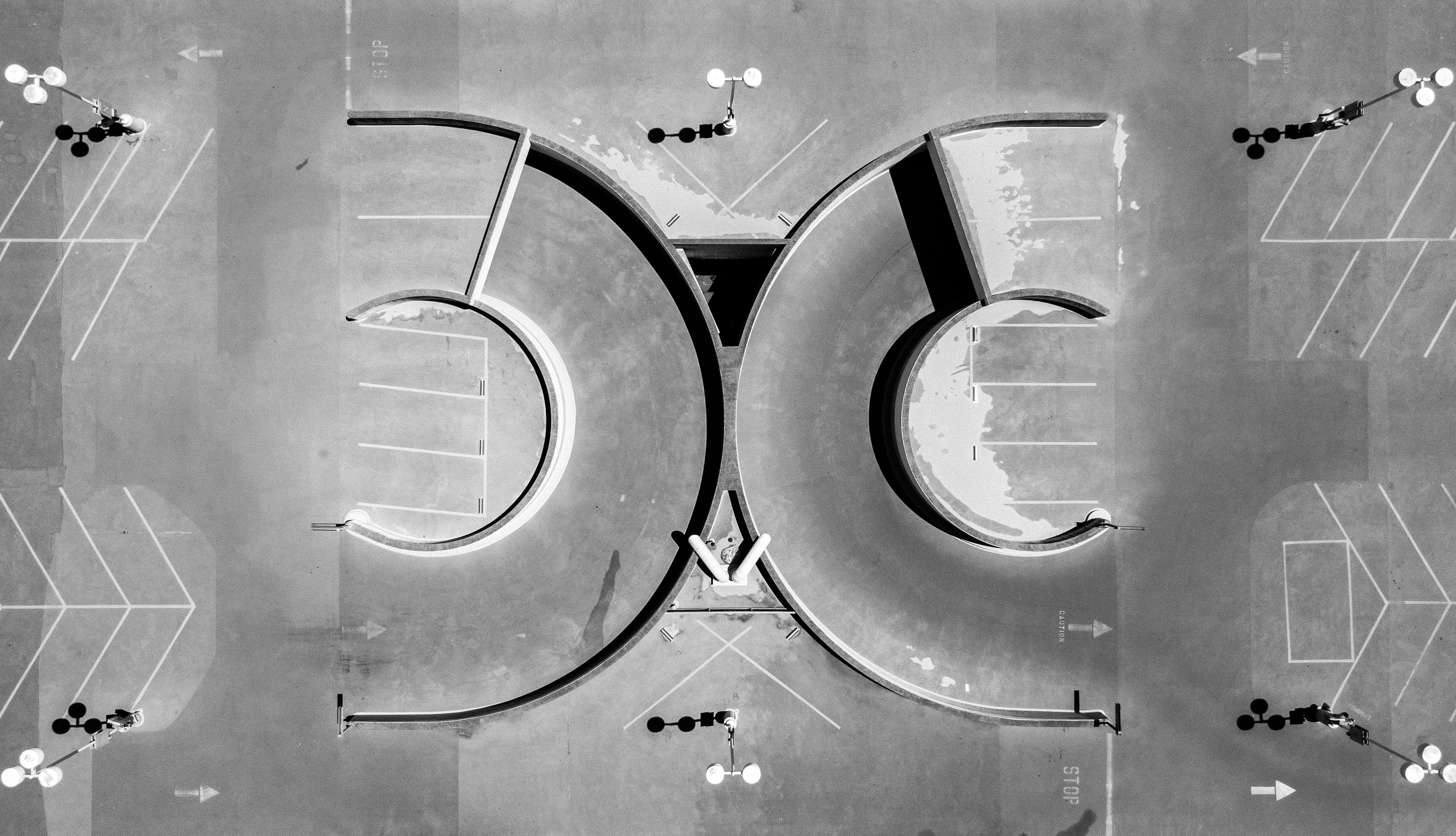 Overhead view of a geometric parking structure with bold lines and curves.