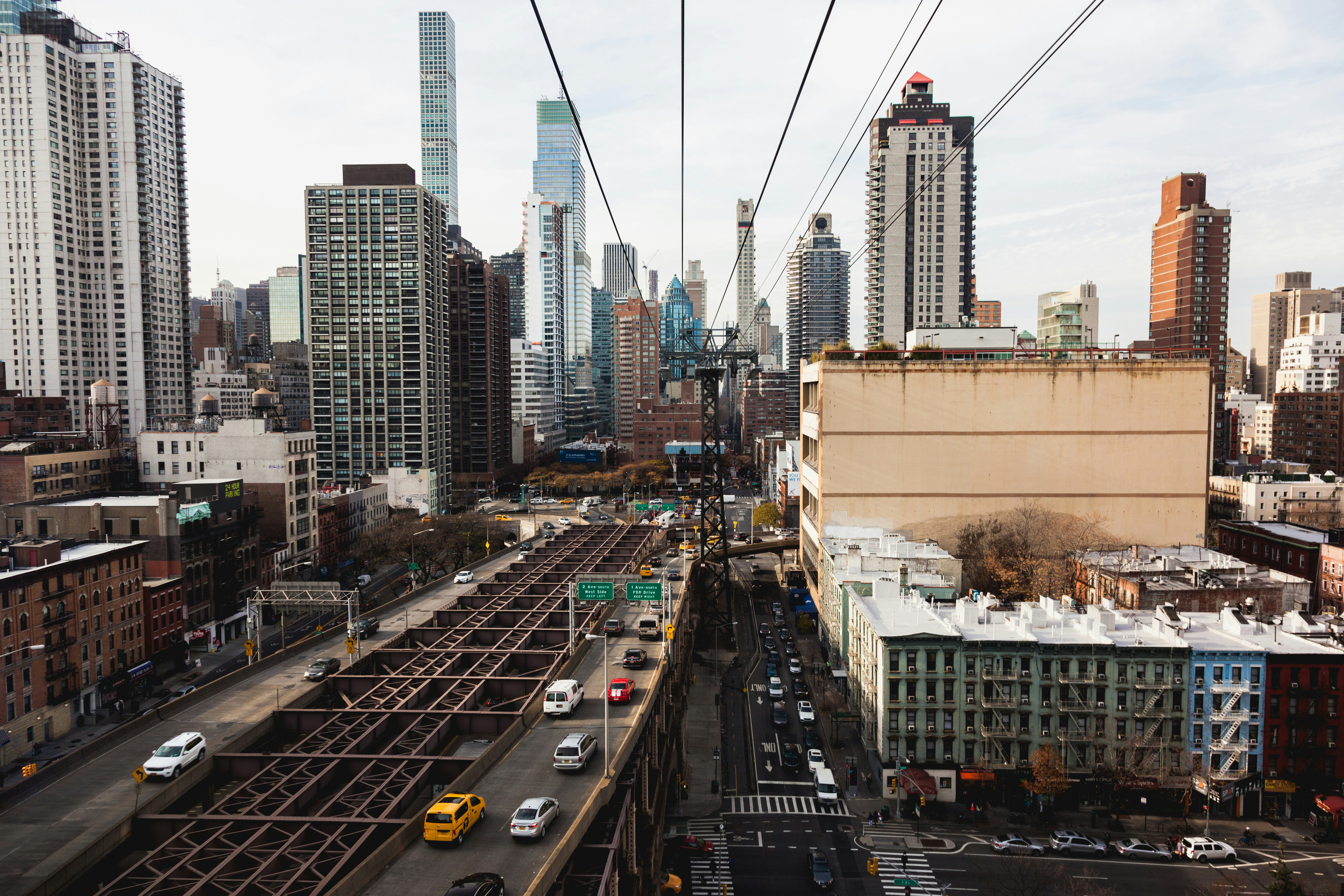 Vanishing Cables and Urban Grid: A Rooftop View Toward the Distant Skyline