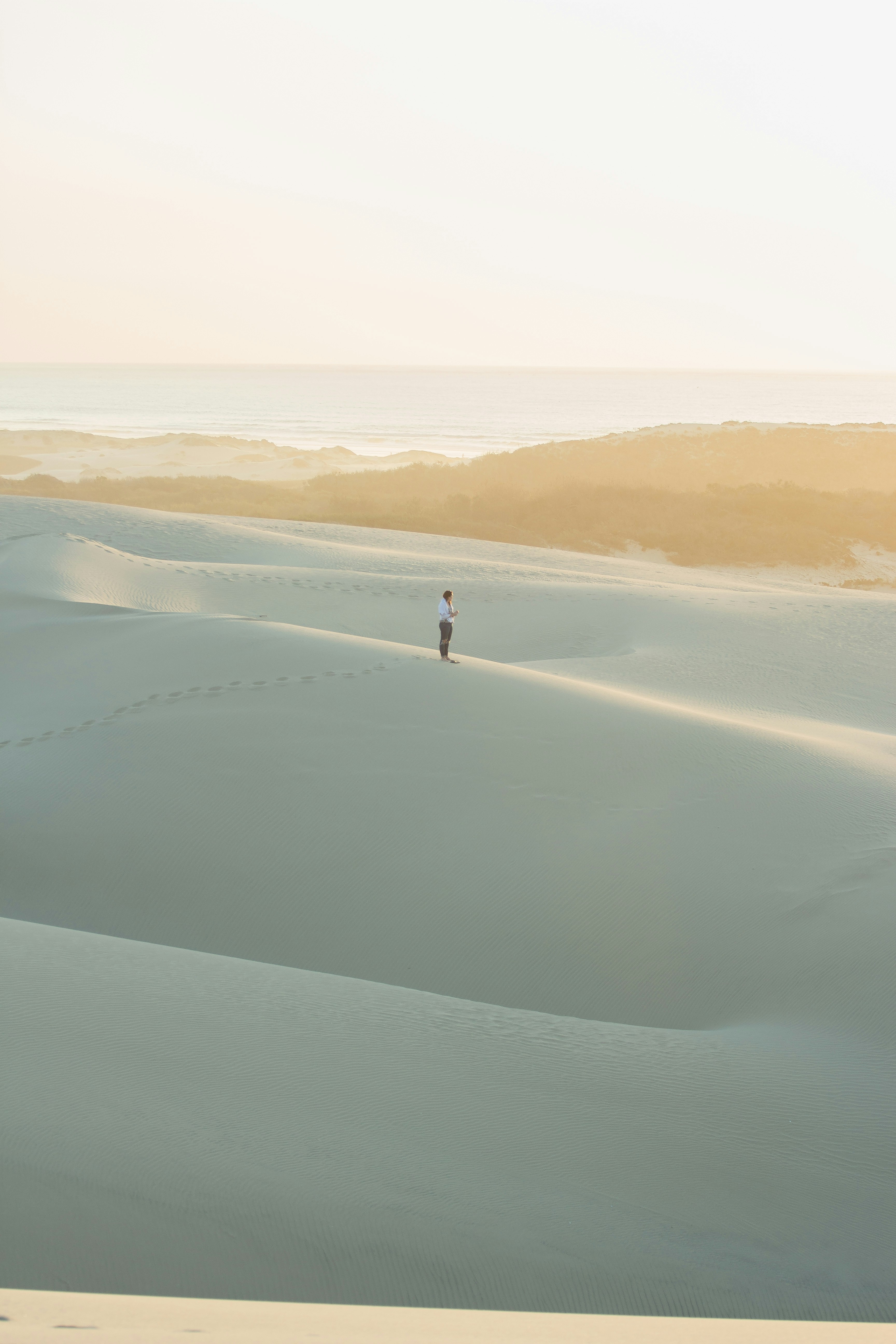 Person standing on sand photo – Free Beach Image on Unsplash