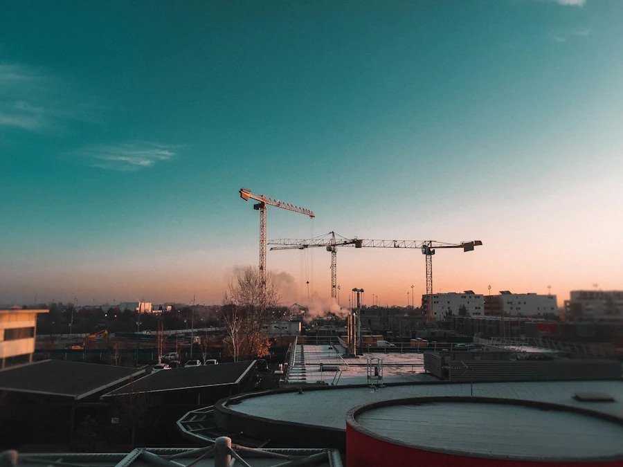 Le matin j’arrive en cours et je vois se paysage, et se lever de soleil. | buildings and tower cranes under blue sky