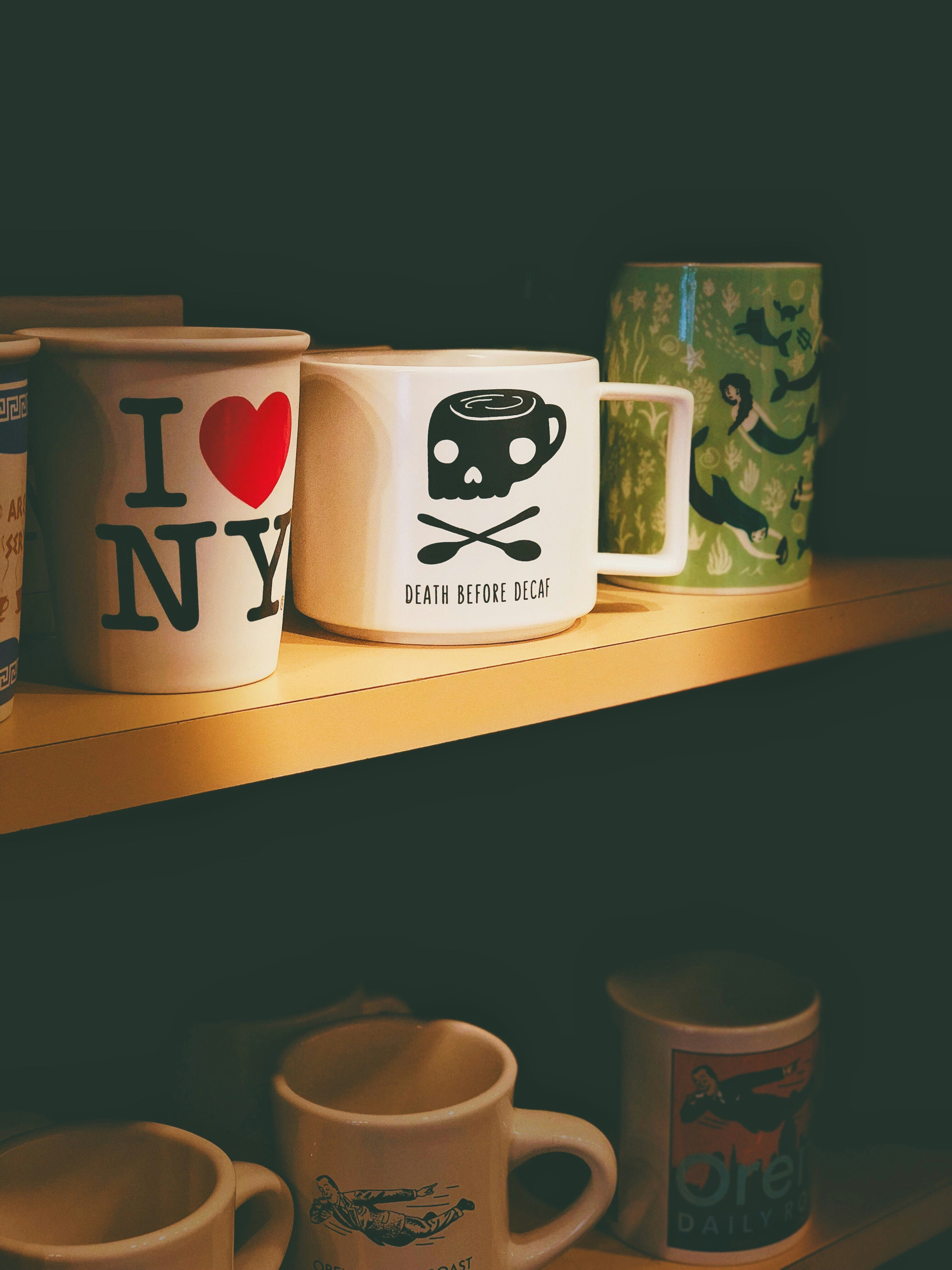 Death Before Decaf: A Quiet Saga of Mugs on a Wooden Shelf