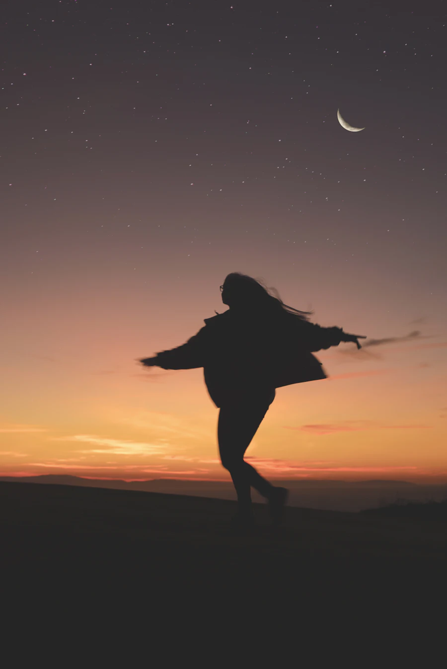 Silhouetted person spinning at sunset under a crescent moon and scattered stars. Warm orange horizon fades into a purple dusk sky.