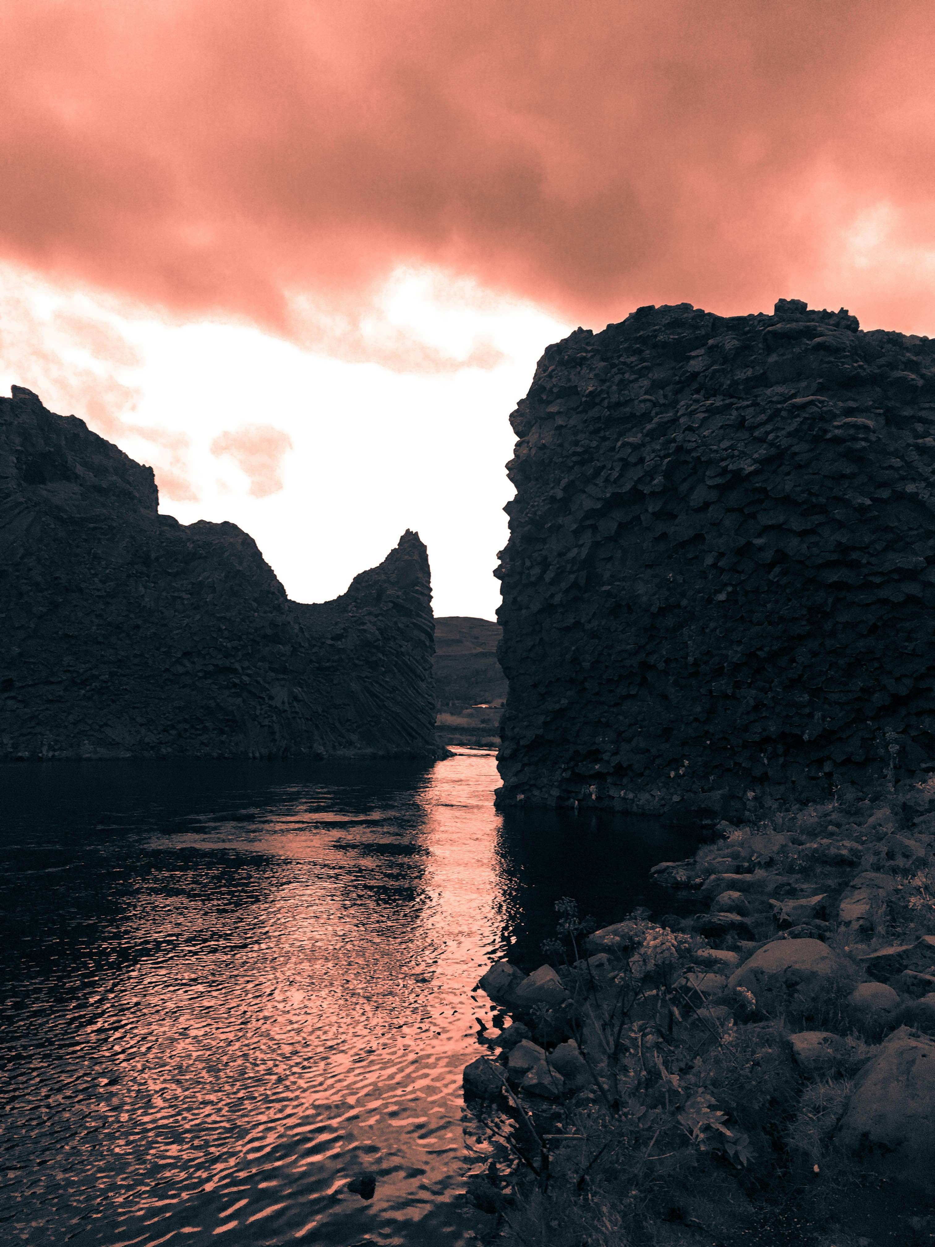 Crimson Gap: Light Reflections Between Basalt Walls