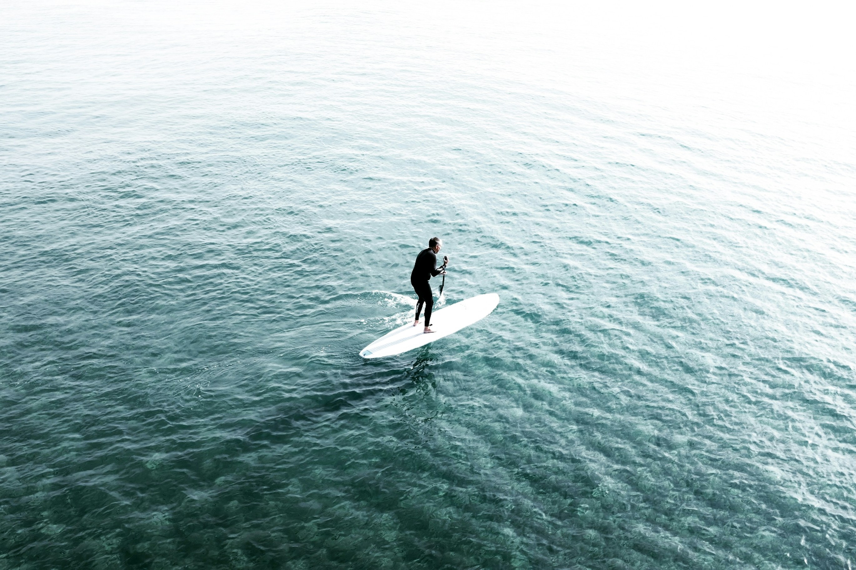 man riding surfboard on body of water photo – Free Newport beach Image ...