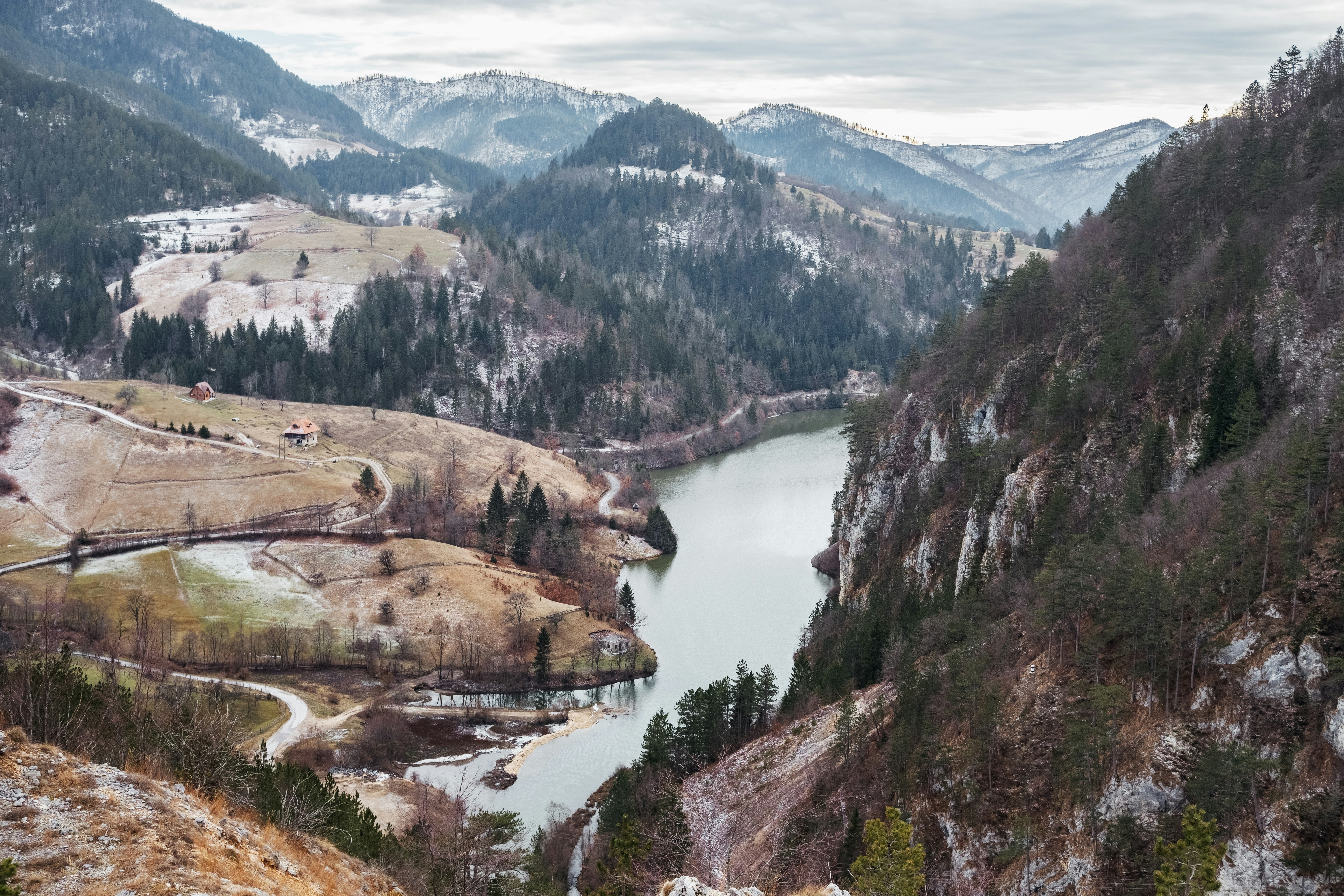 Ribbon of Winter Silk: Winding River Through Snow-Dusted Valleys