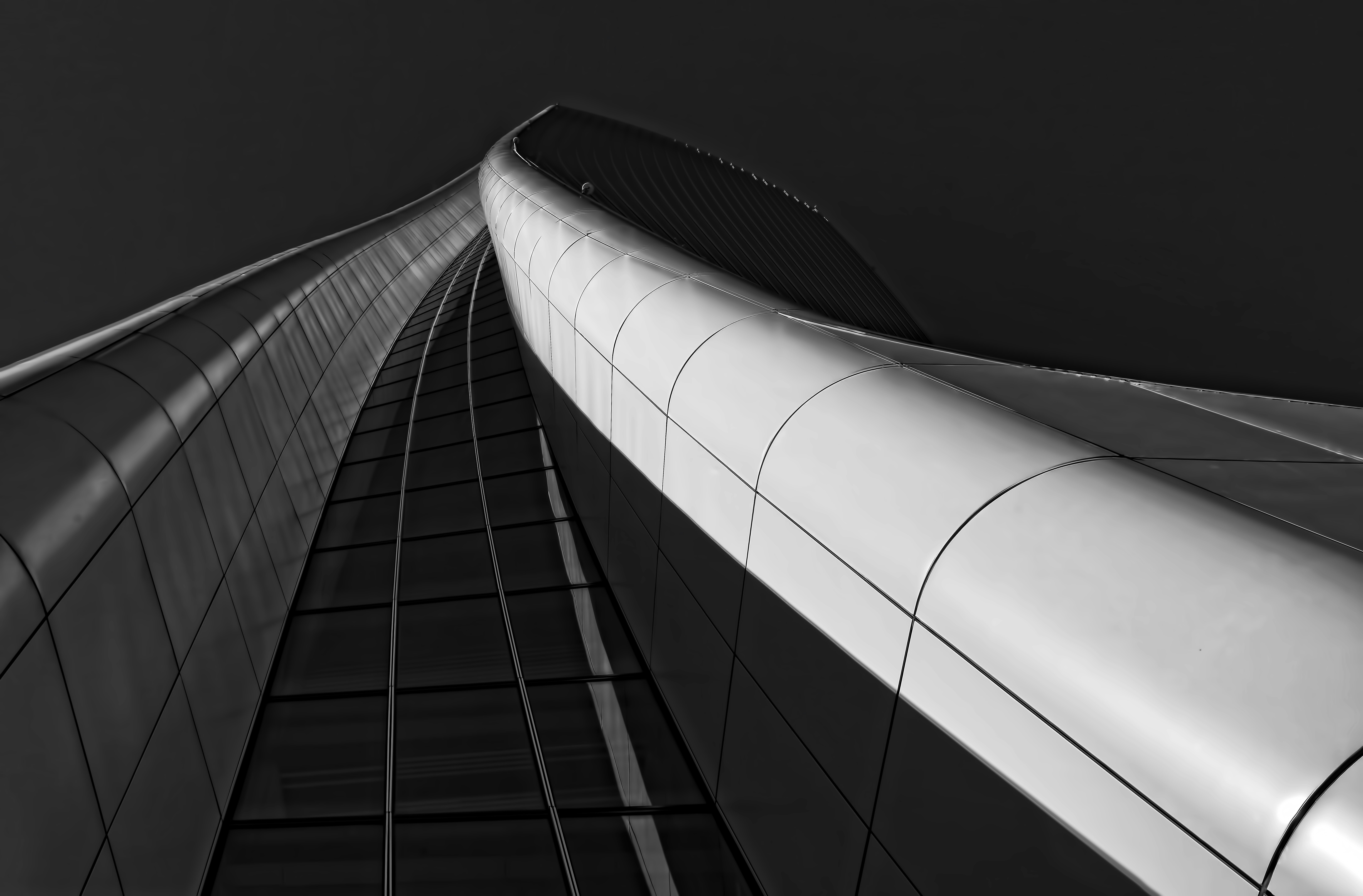 Curves Converge Toward a Circular Aperture: A Low-Angle Architectural Portrait
