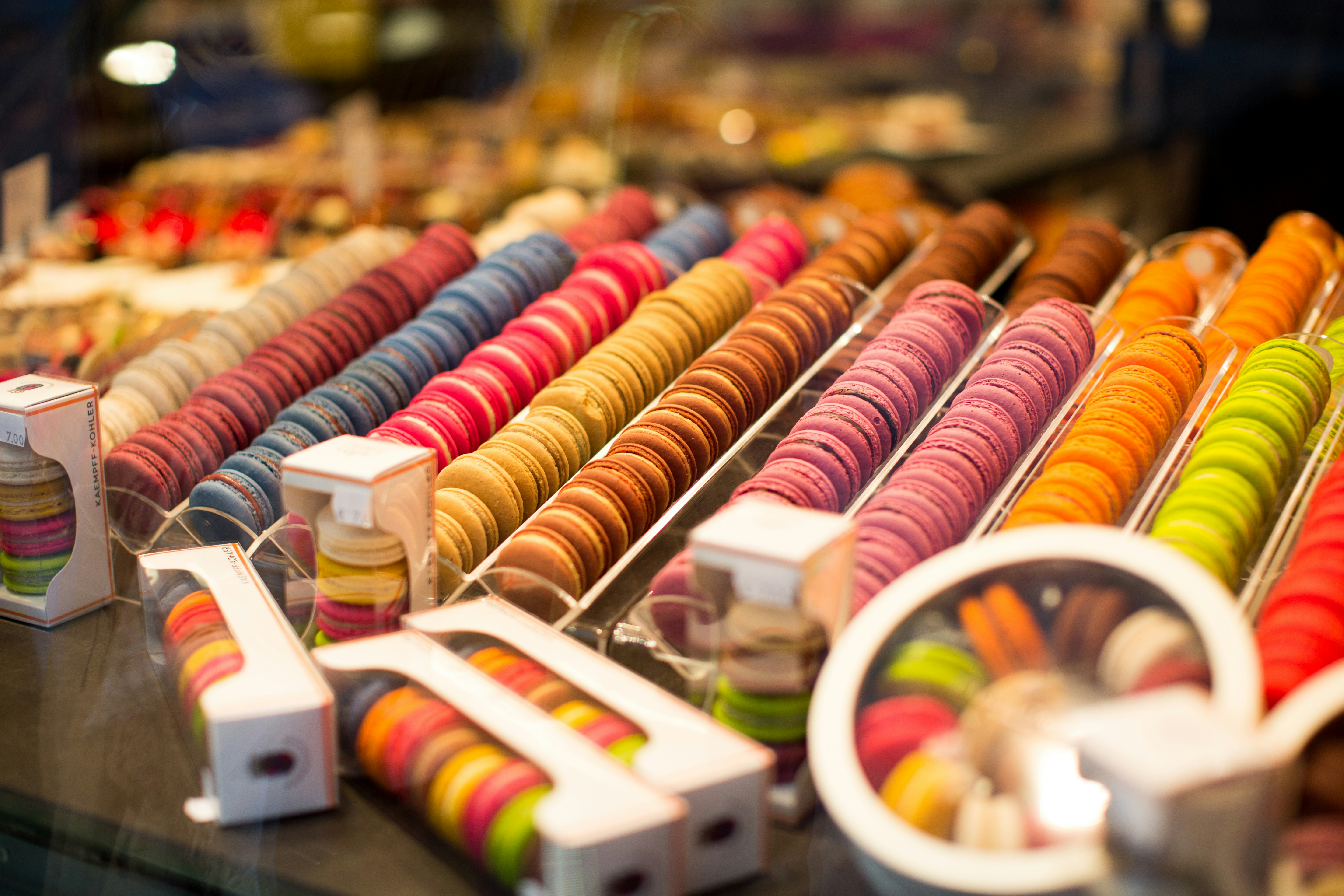 Vibrant rows of macarons in various colors and flavors arranged in an enticing display. The assortment showcases the artistry of pastry making.