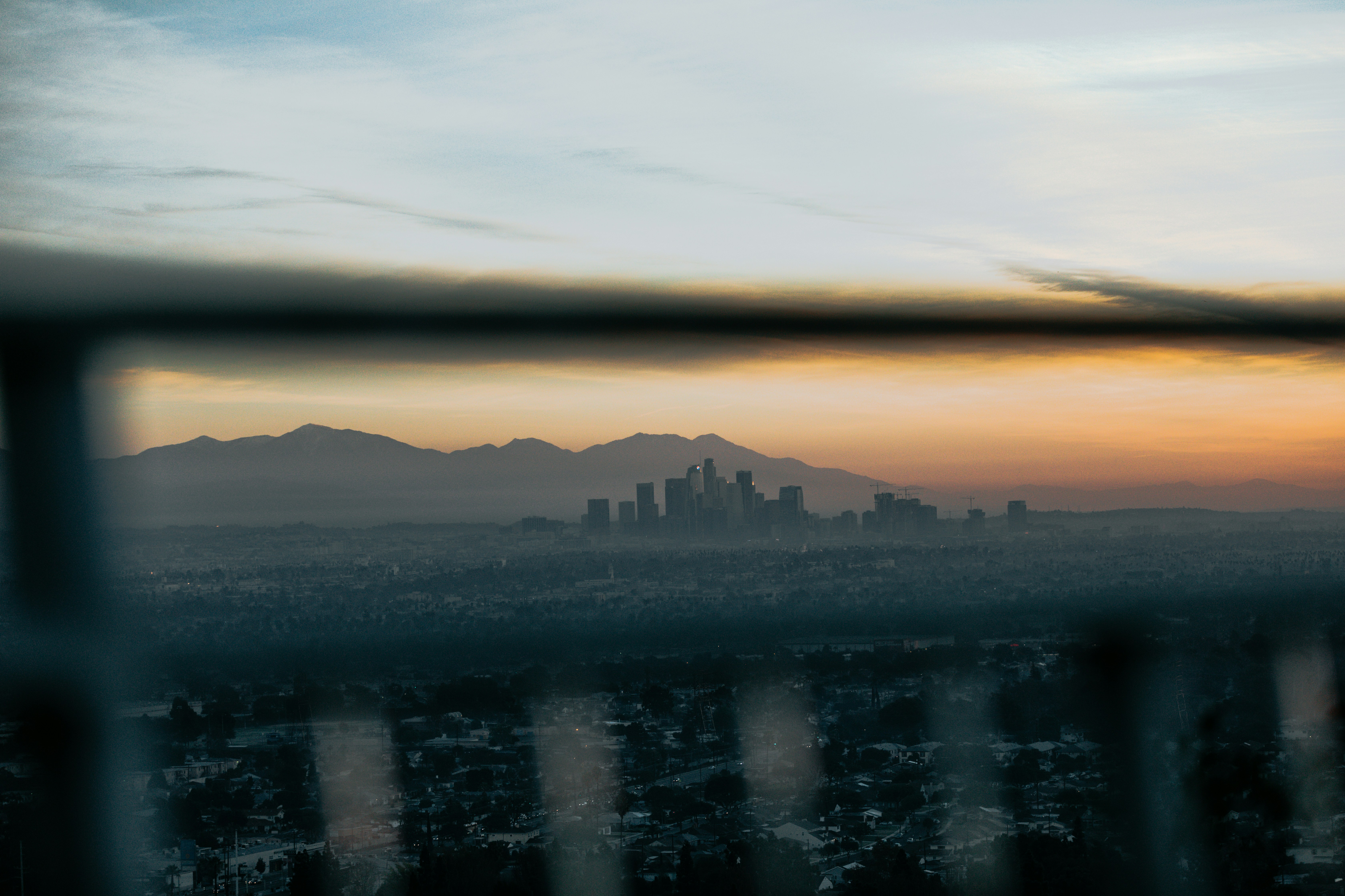 city with high-rise buildings viewing mountain during night timeNathan Dumlao
