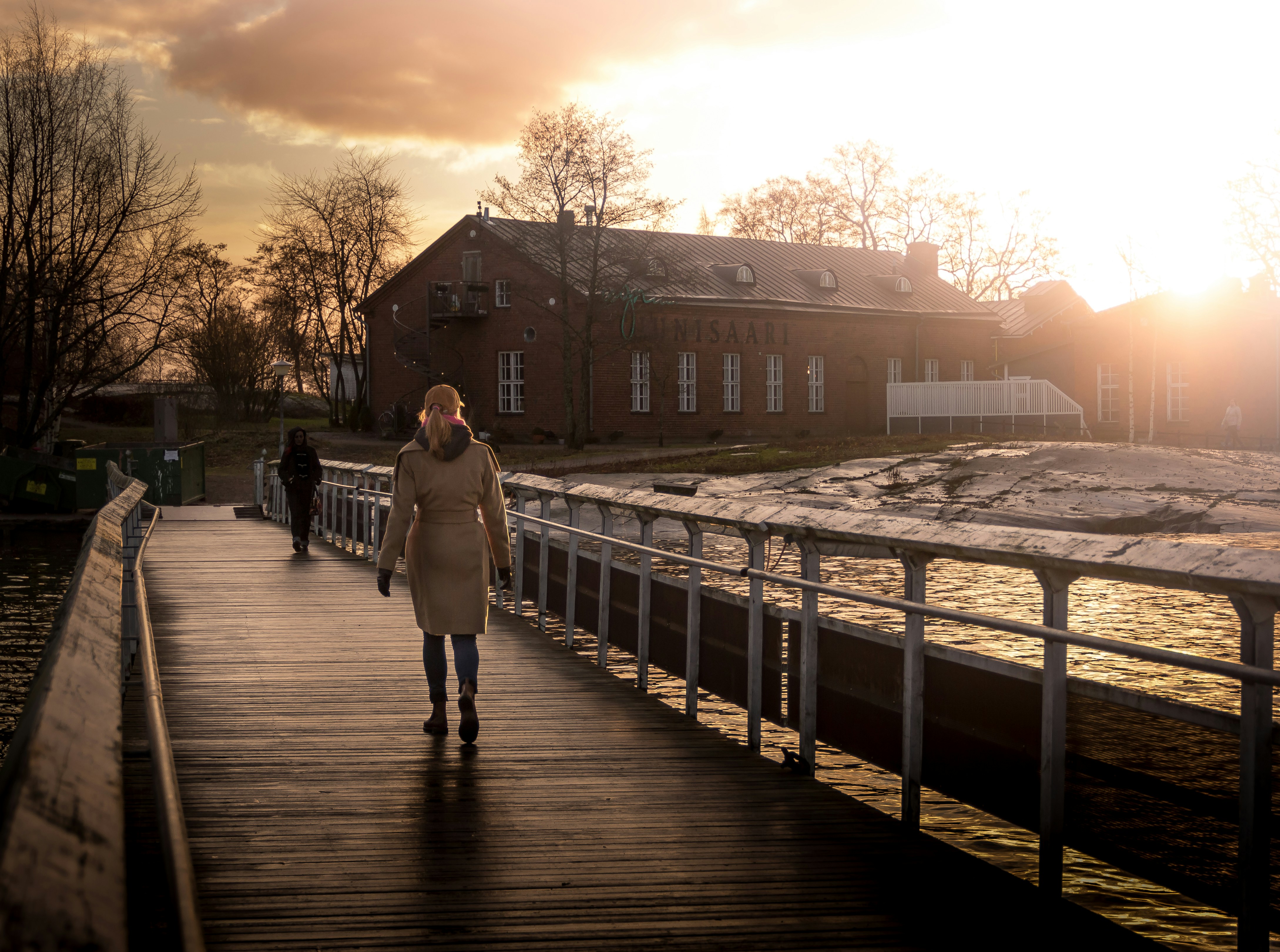 Sunset Crossing on the River Bridge: A lone figure strides toward the glow.