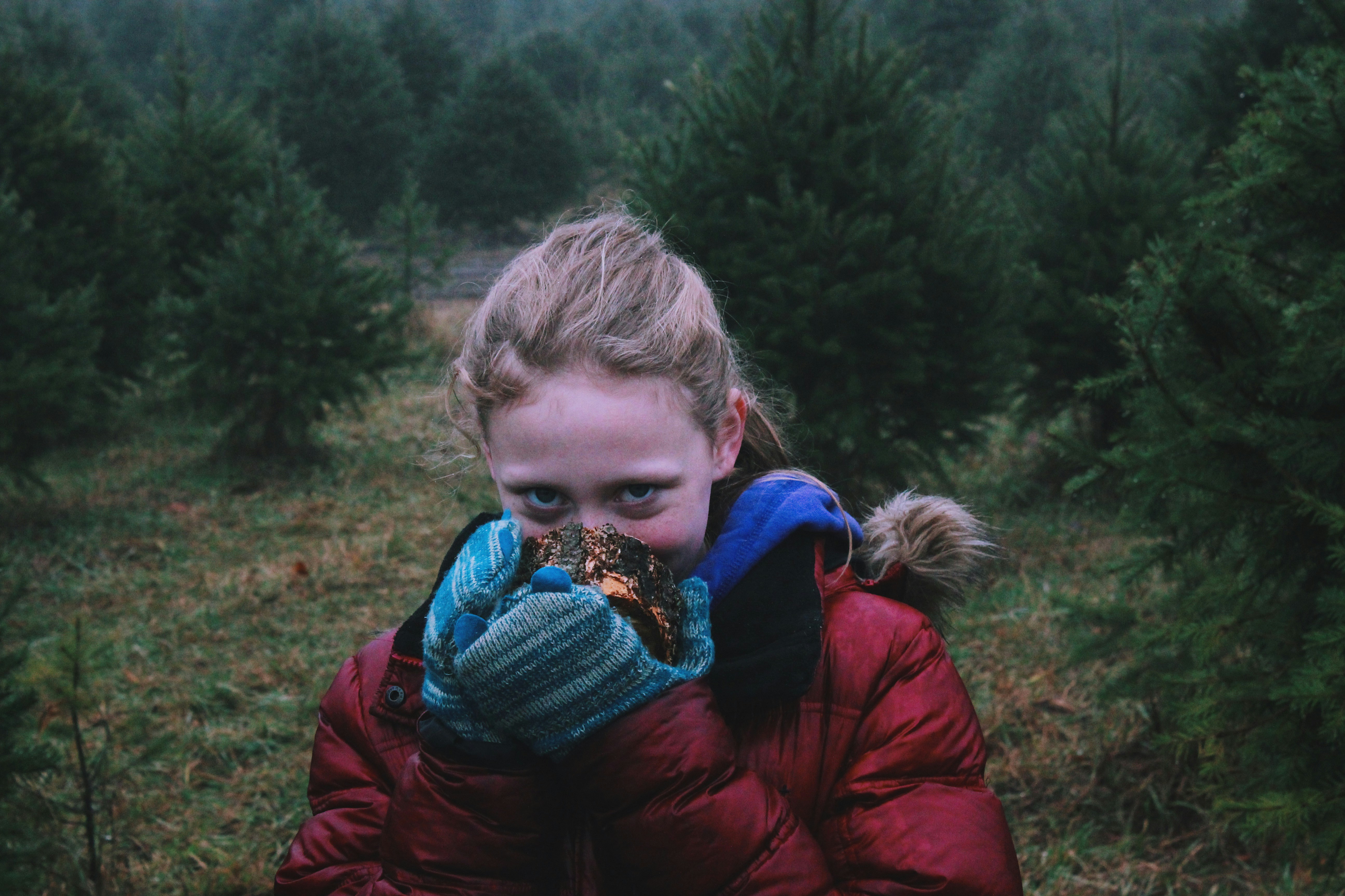 Woman wearing red jacket covering her nose photo – Free People Image on ...