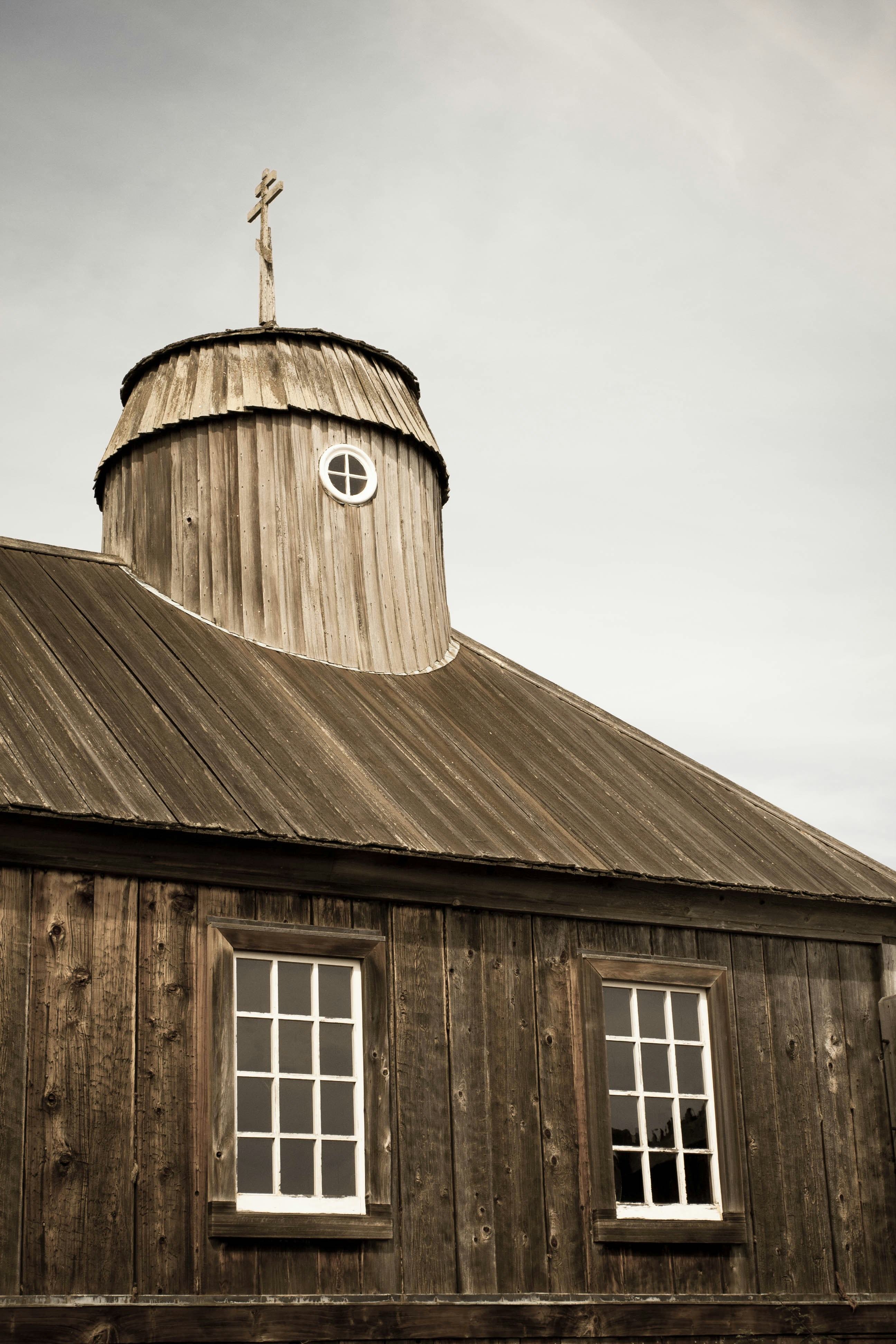 Cupola Crowned in Sepia: A Weathered Timber Church