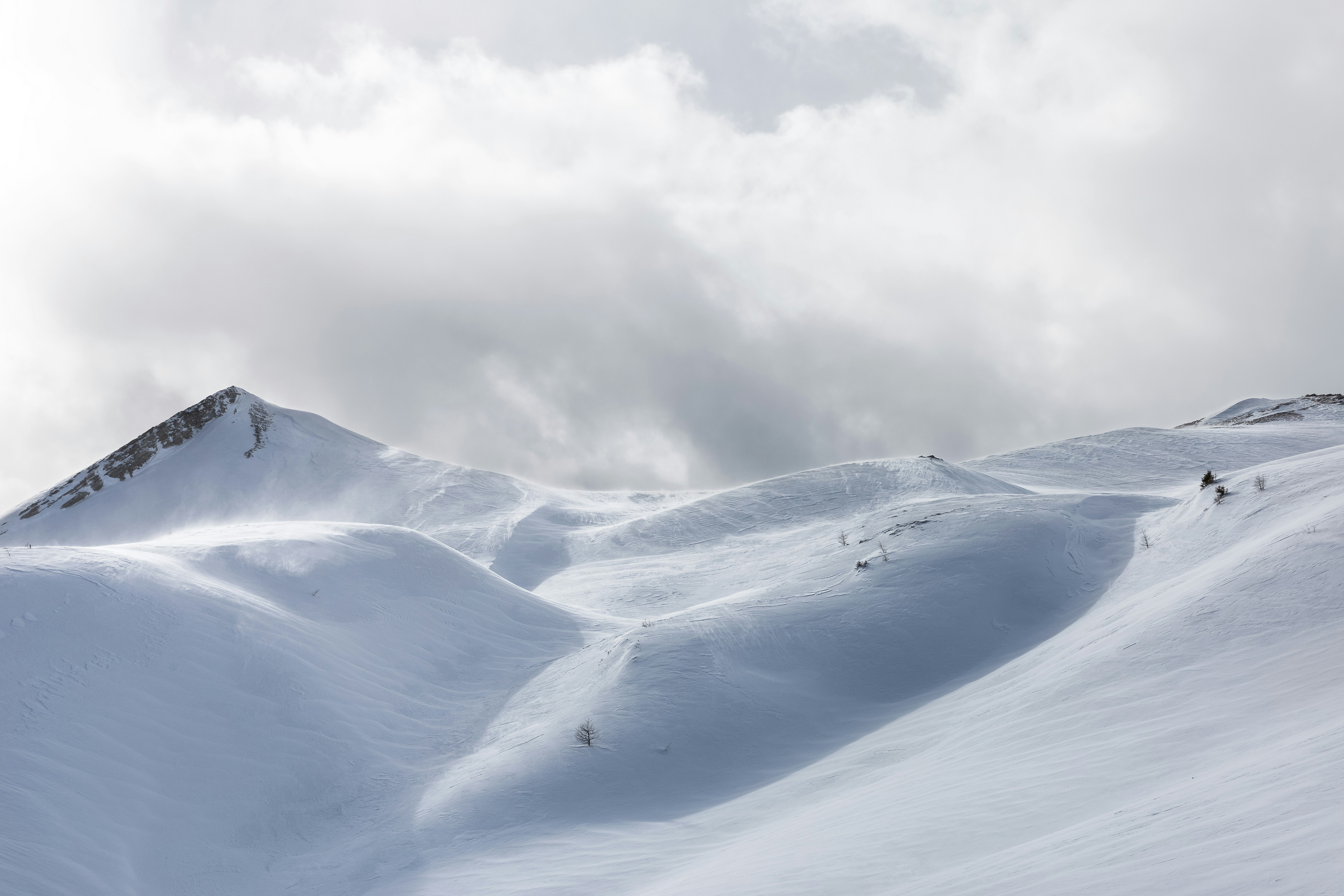 After a long hike and an unexpected blizzard I saw this spectacular landscape. | white snow mountain under cloudy sky