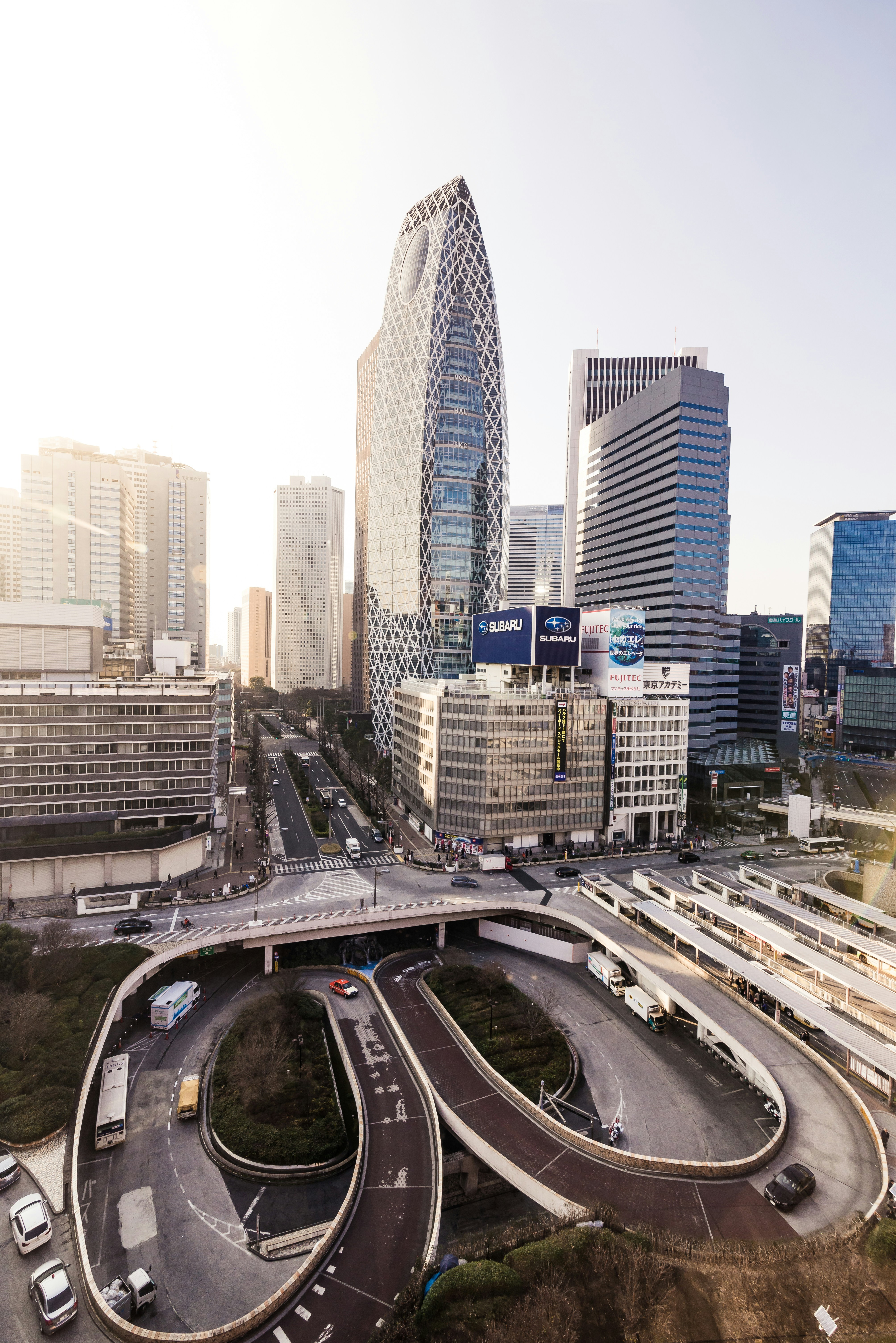 Aerial view of a bustling cityscape featuring modern skyscrapers and intricate roadways, highlighting urban architecture and transportation dynamics.