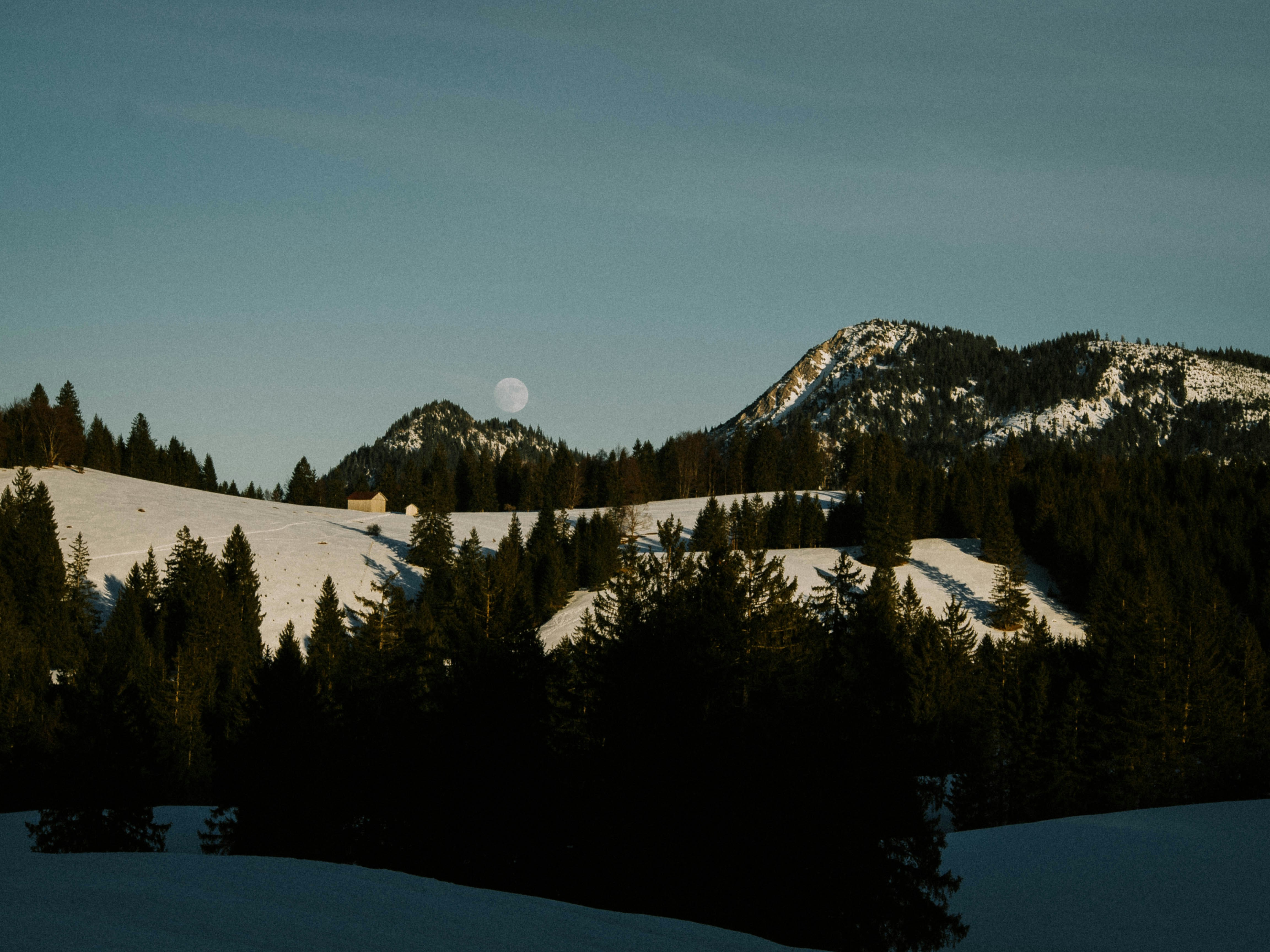 Moon Over a Snow-Dusted Alpine Ridge
