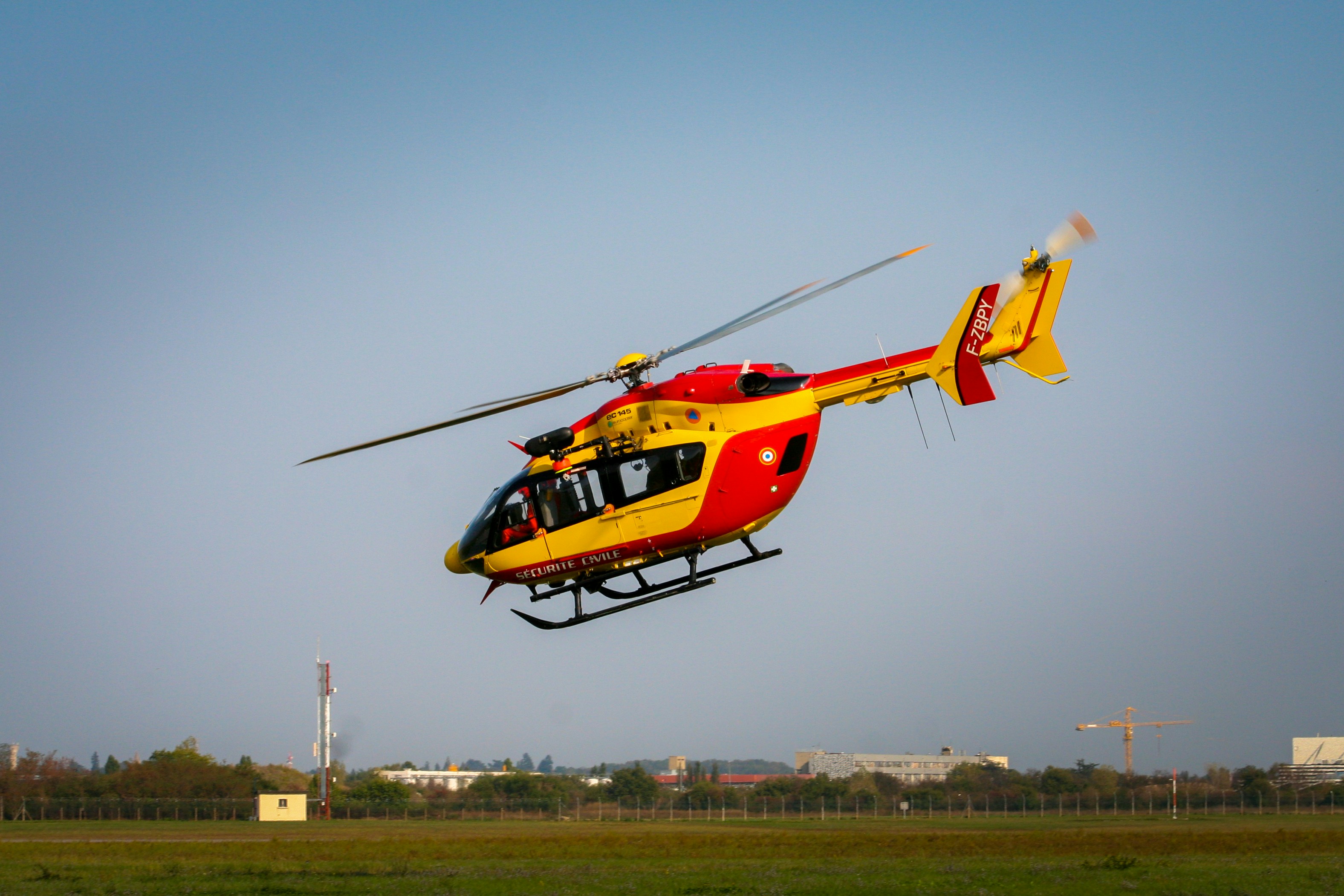 Taking off to rescue | yellow and red helicopter on the sky