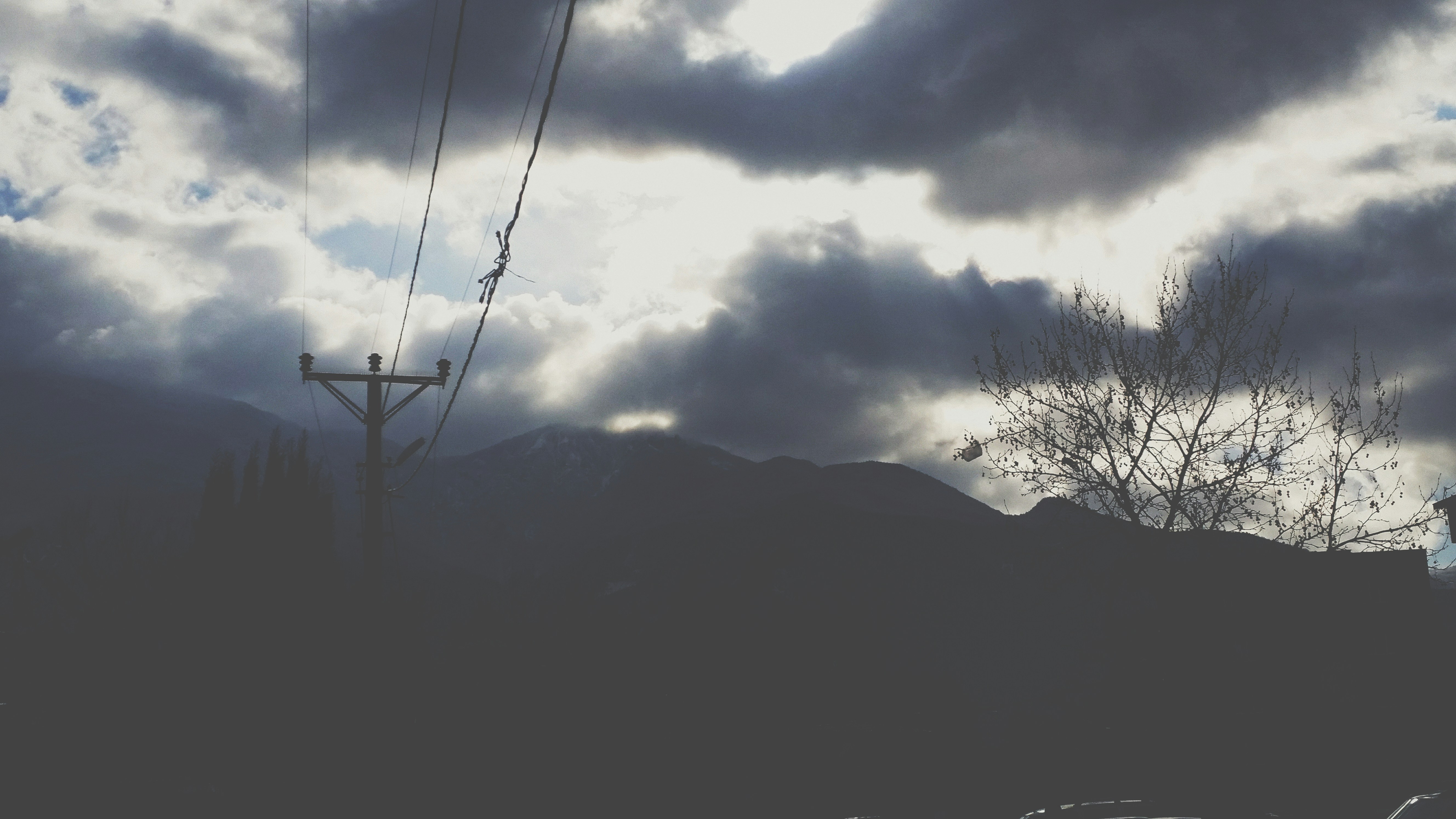 Ominous Clouds Over Silhouetted Landscape