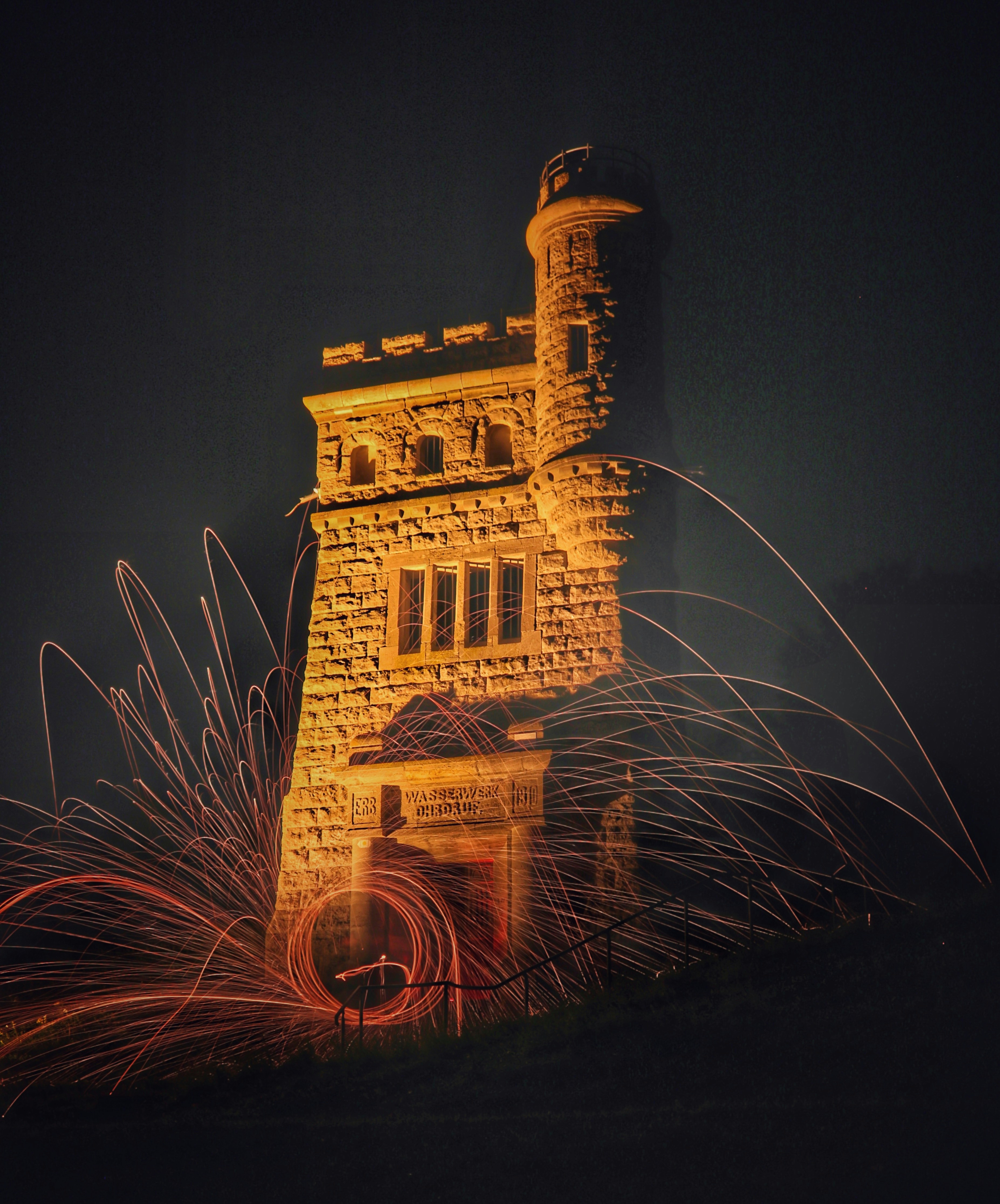 time lapse photography of steel wool beside concrete building