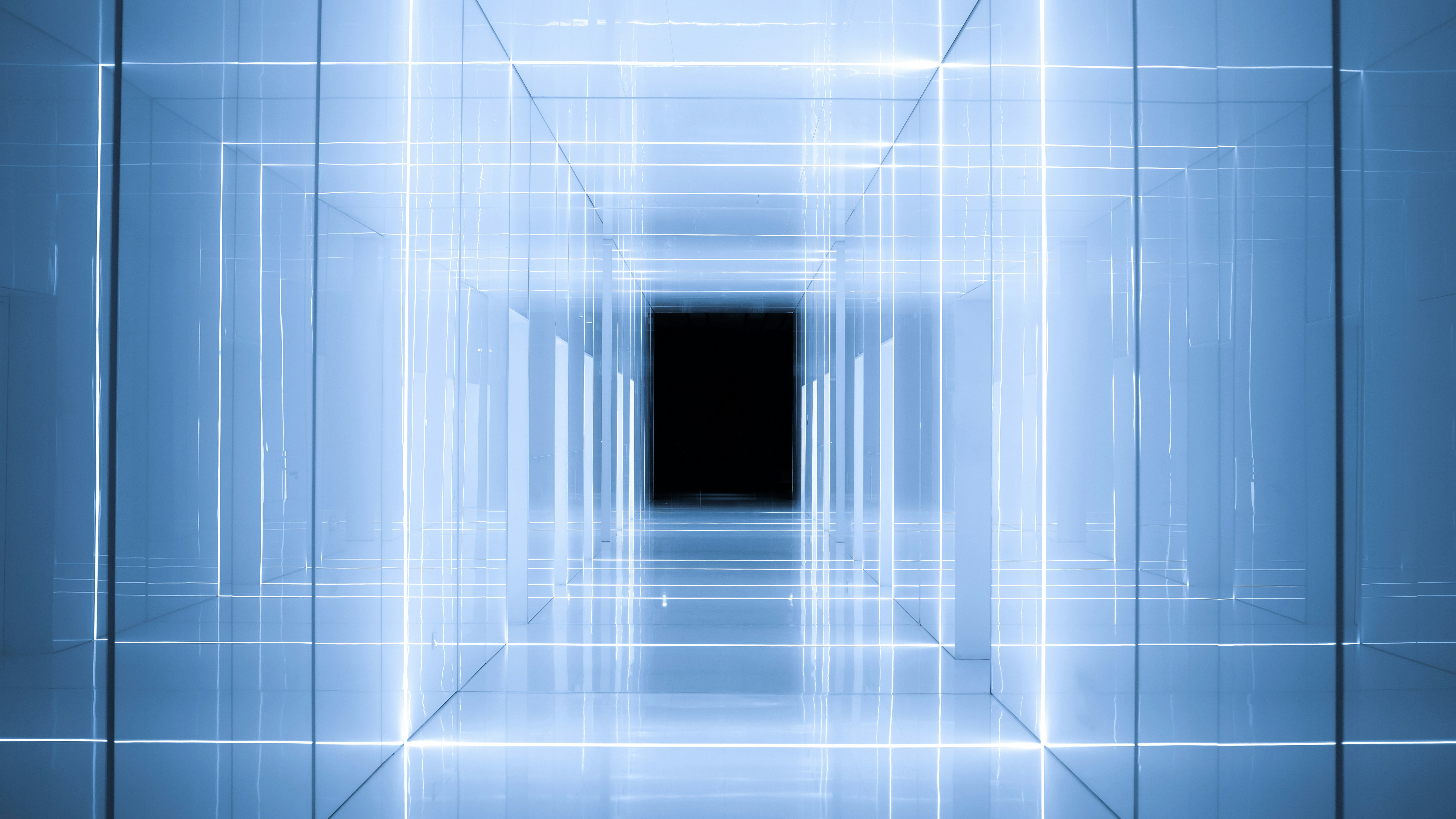 Illuminated hallway with glowing lines creating a perspective of endless depth.