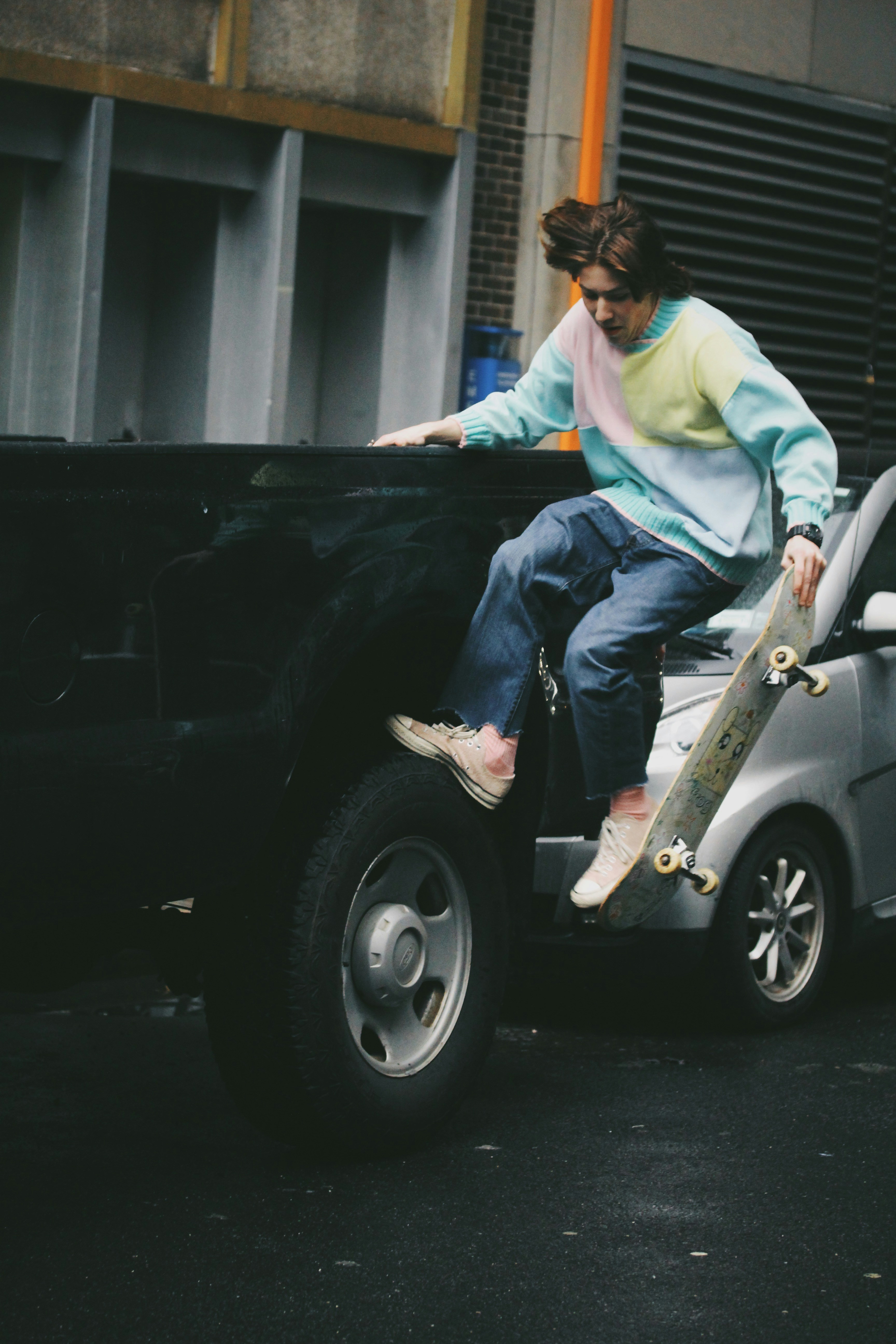 Pastel Skater Clings to the Edge: An Urban Alley Moment by a Parked Car