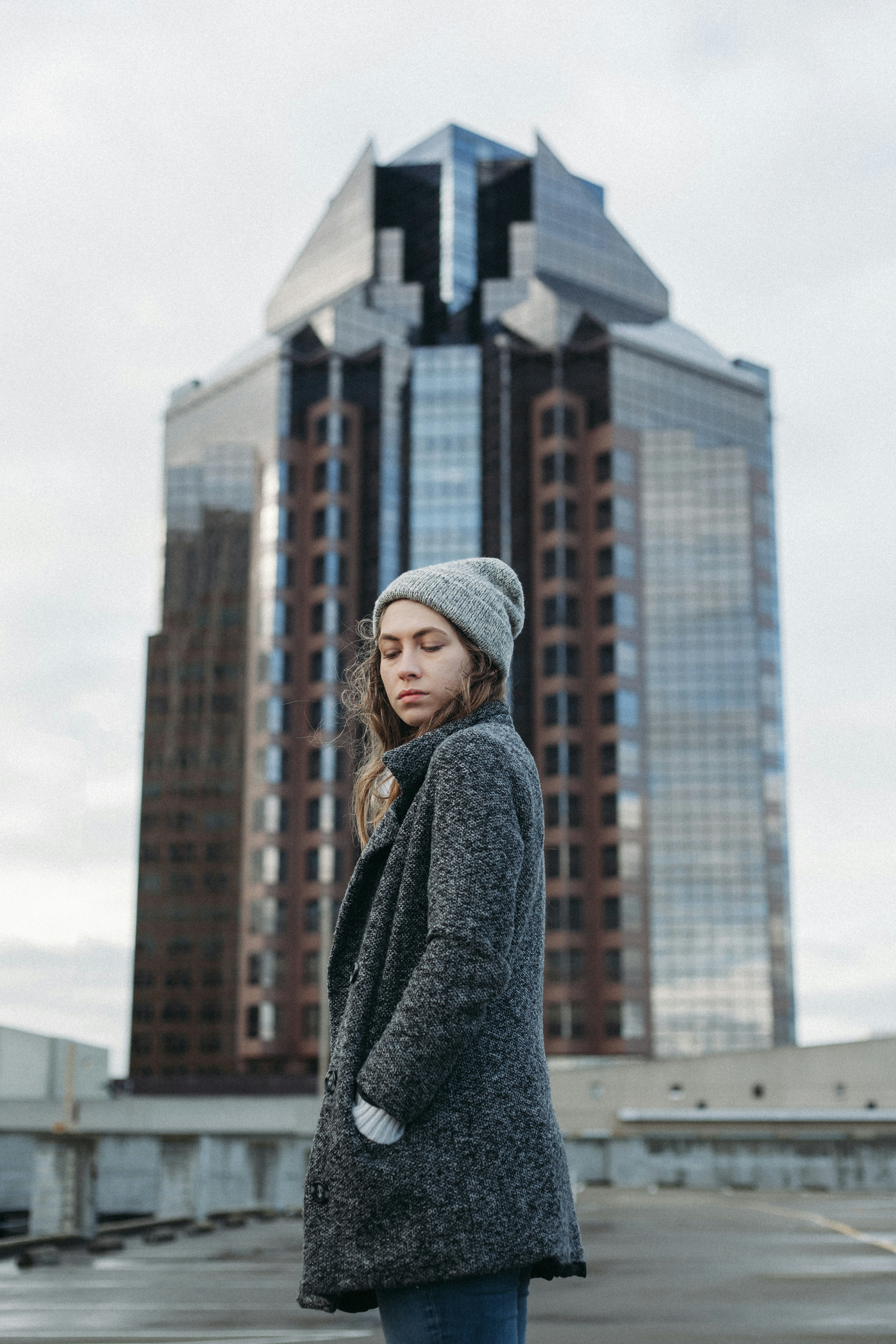 Woman standing behind high rise building during daytime photo – Free ...
