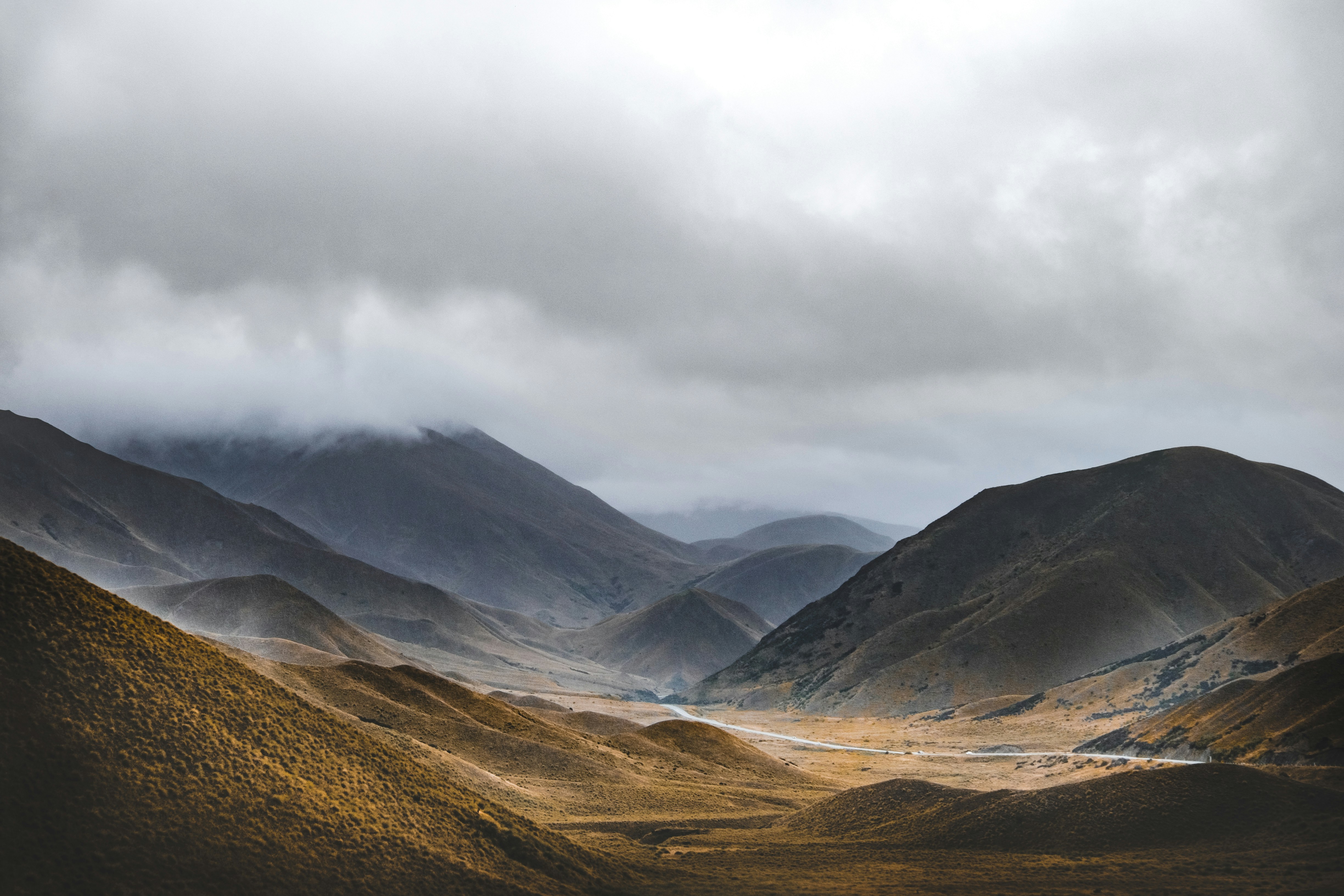 Cloud-covered mountains and valleys under a moody sky.