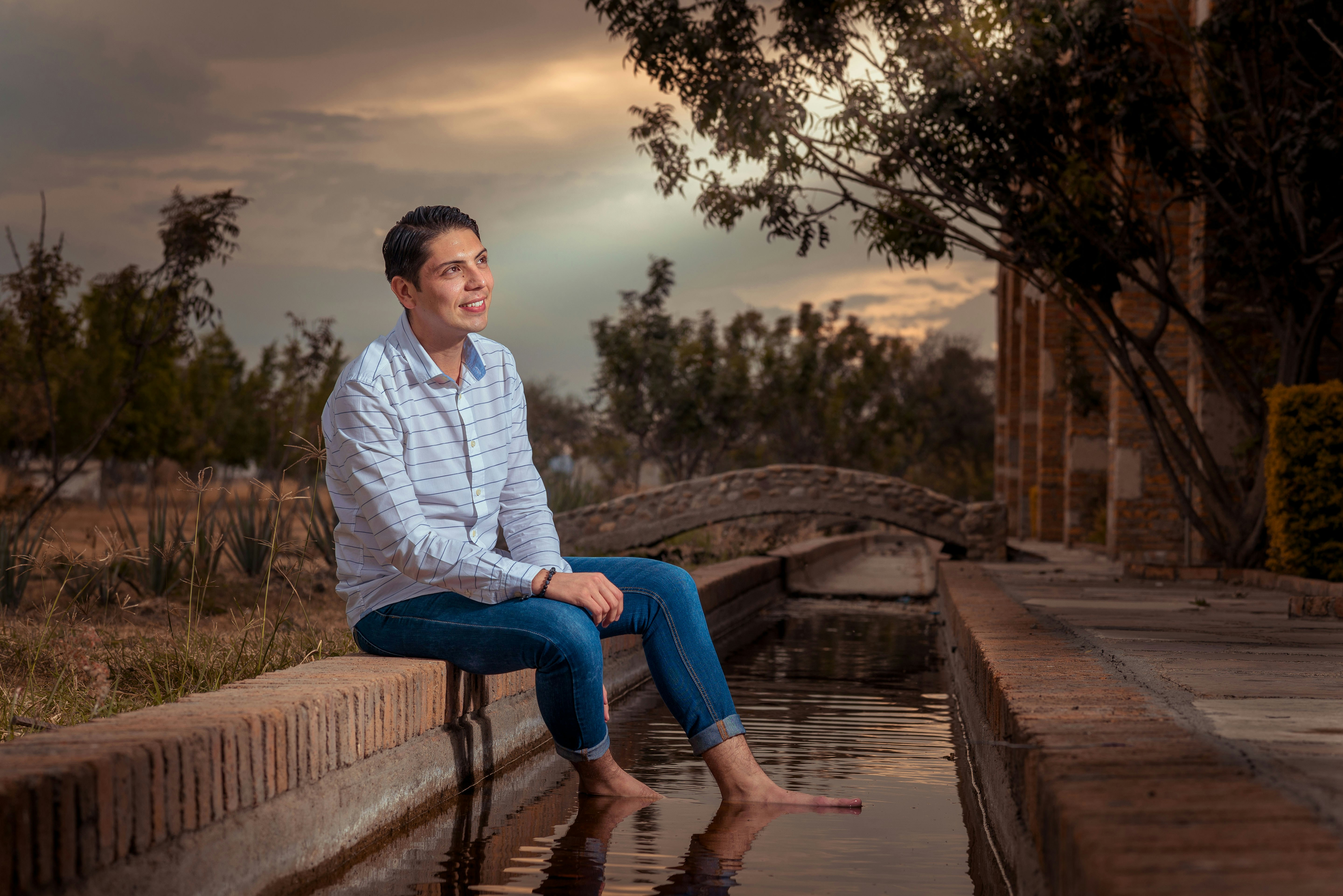 Man sitting on brick photo – Free Bridge Image on Unsplash