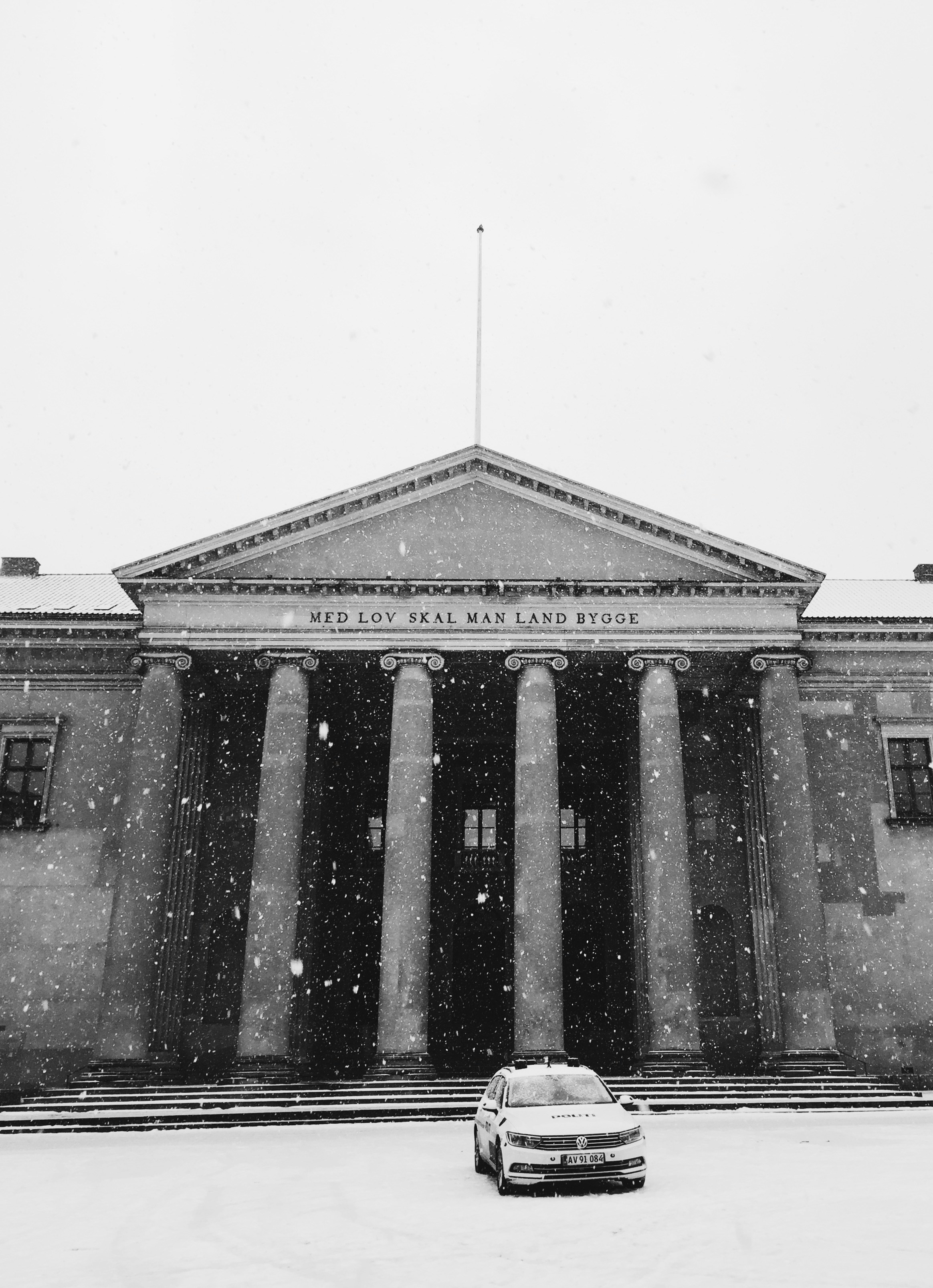 Lone Car Beneath the Snow-Kissed Portico