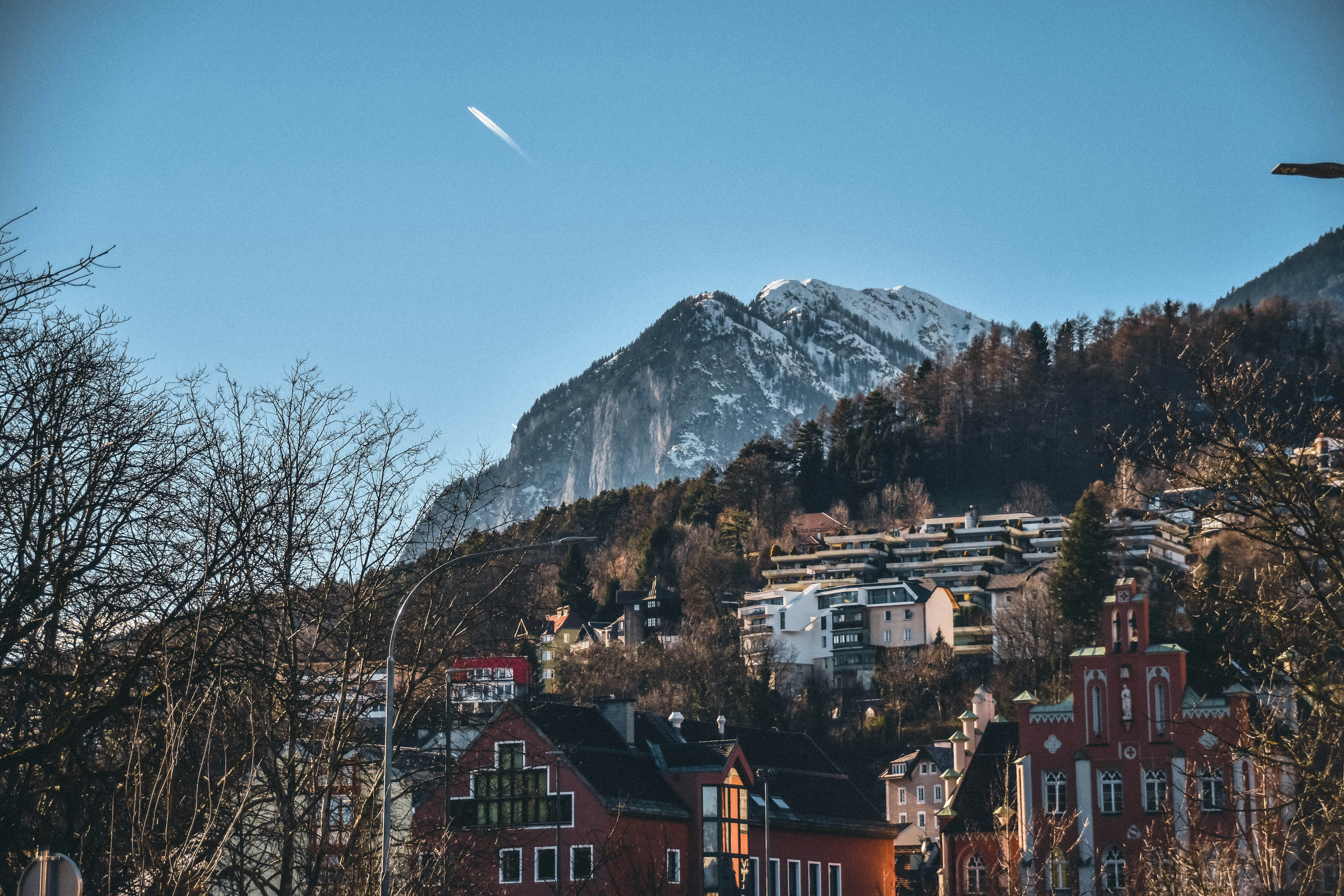 Crimson Town Beneath a Snow-Dusted Alpine Peak