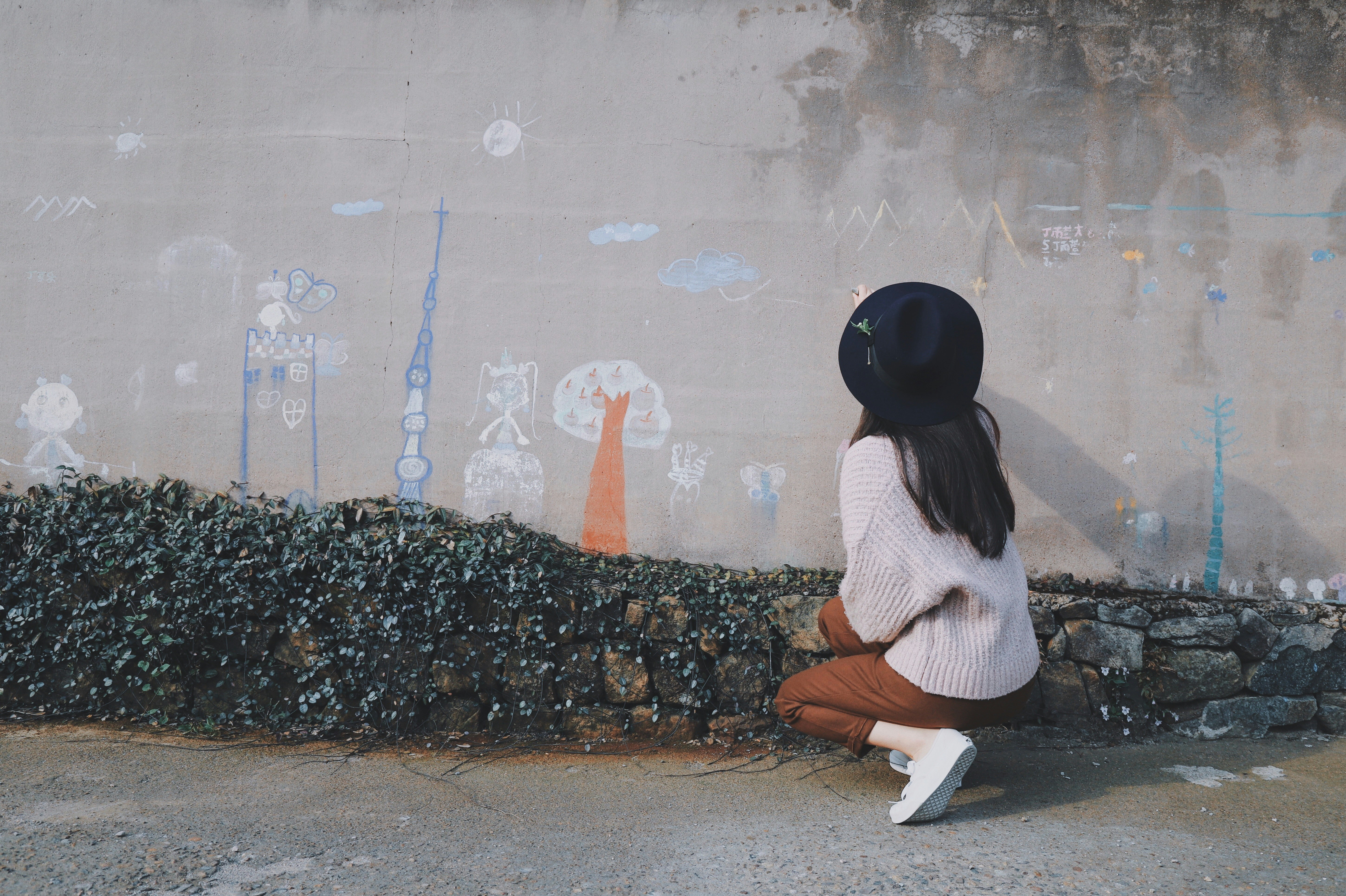 Crouch by Color: Quiet Portrait at a Graffiti Wall