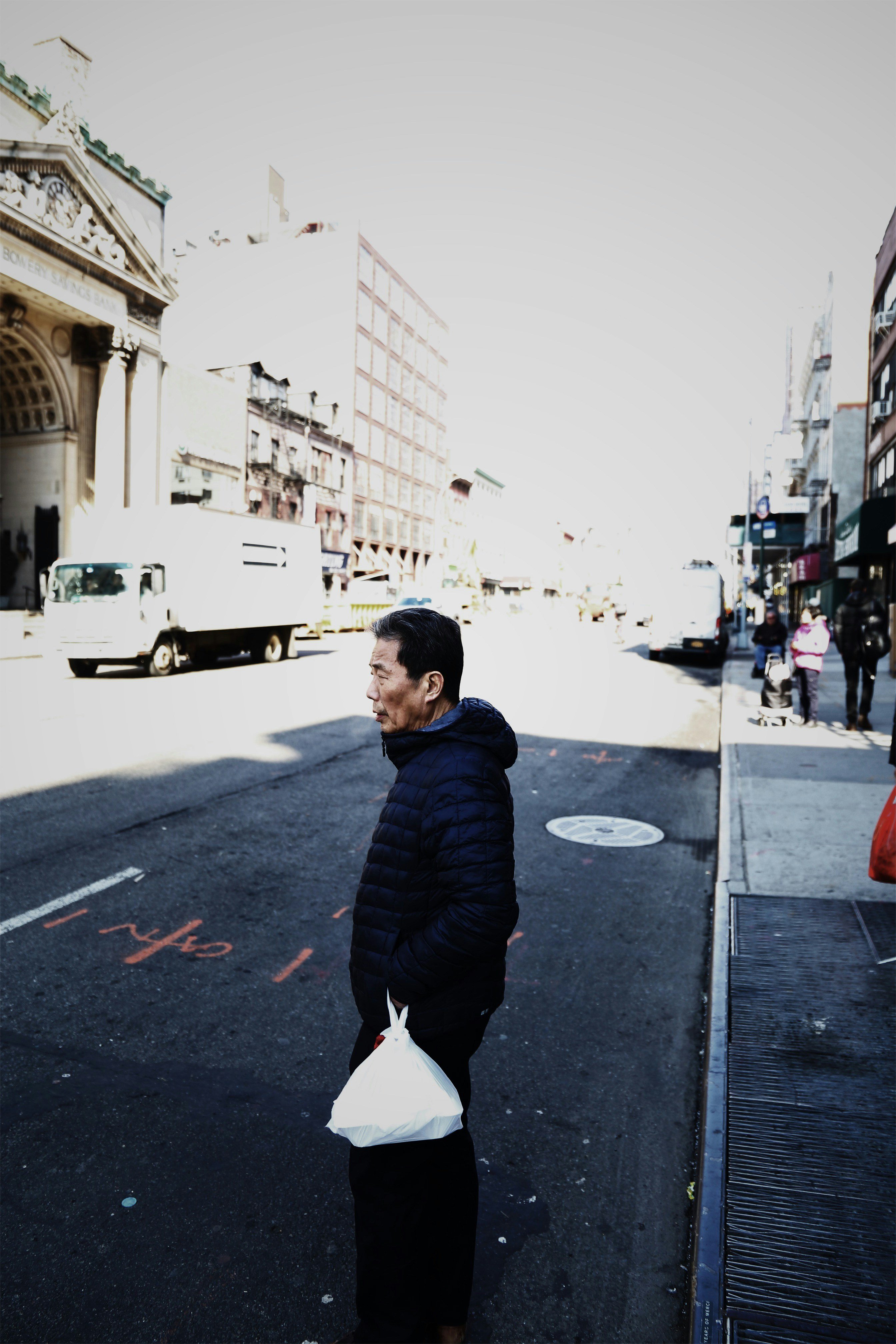 Solitary Pause on a Sunlit City Street