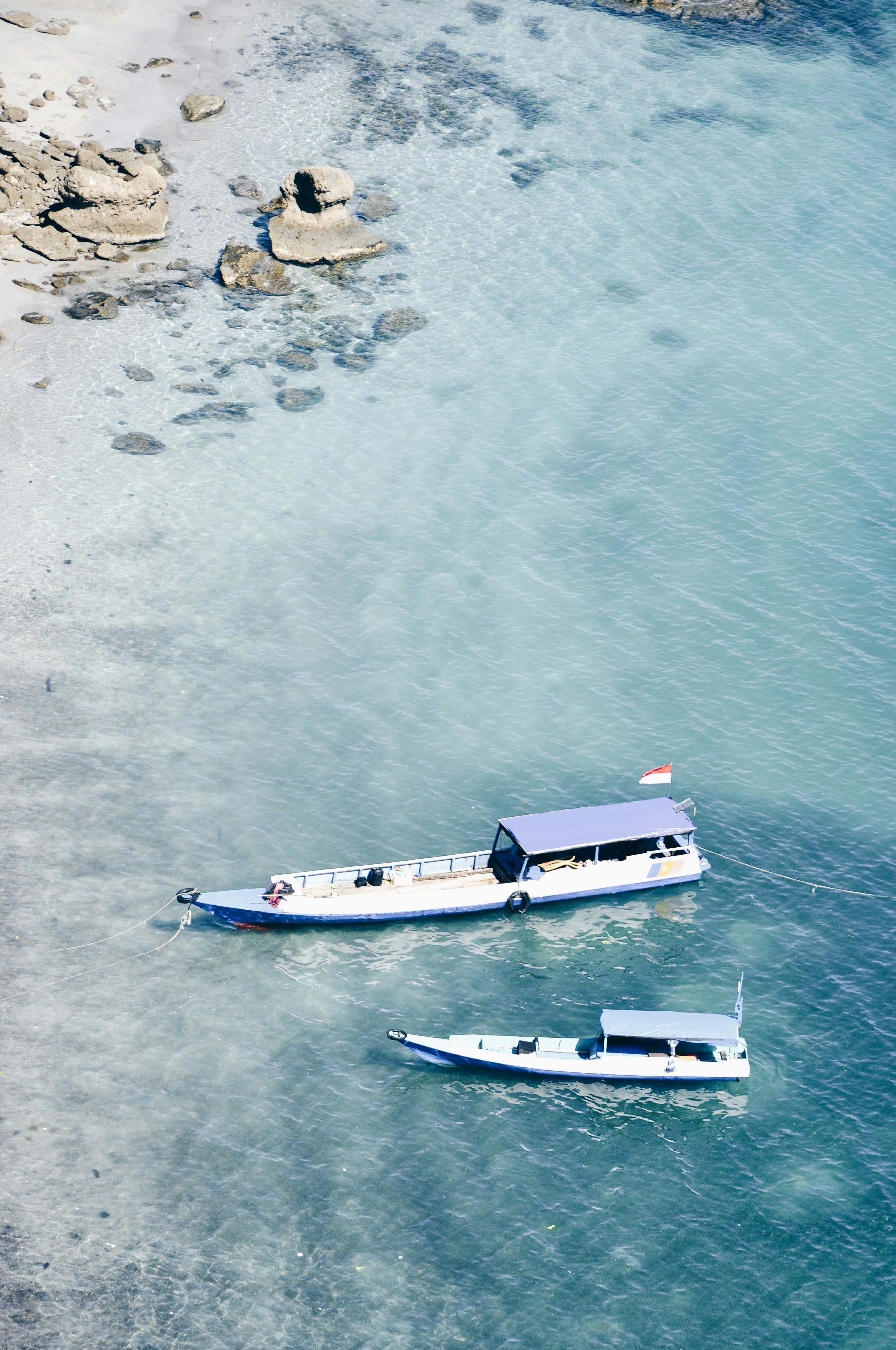 Exploring Komodo National park in Indonesia | two motor boat on body of water at daytime