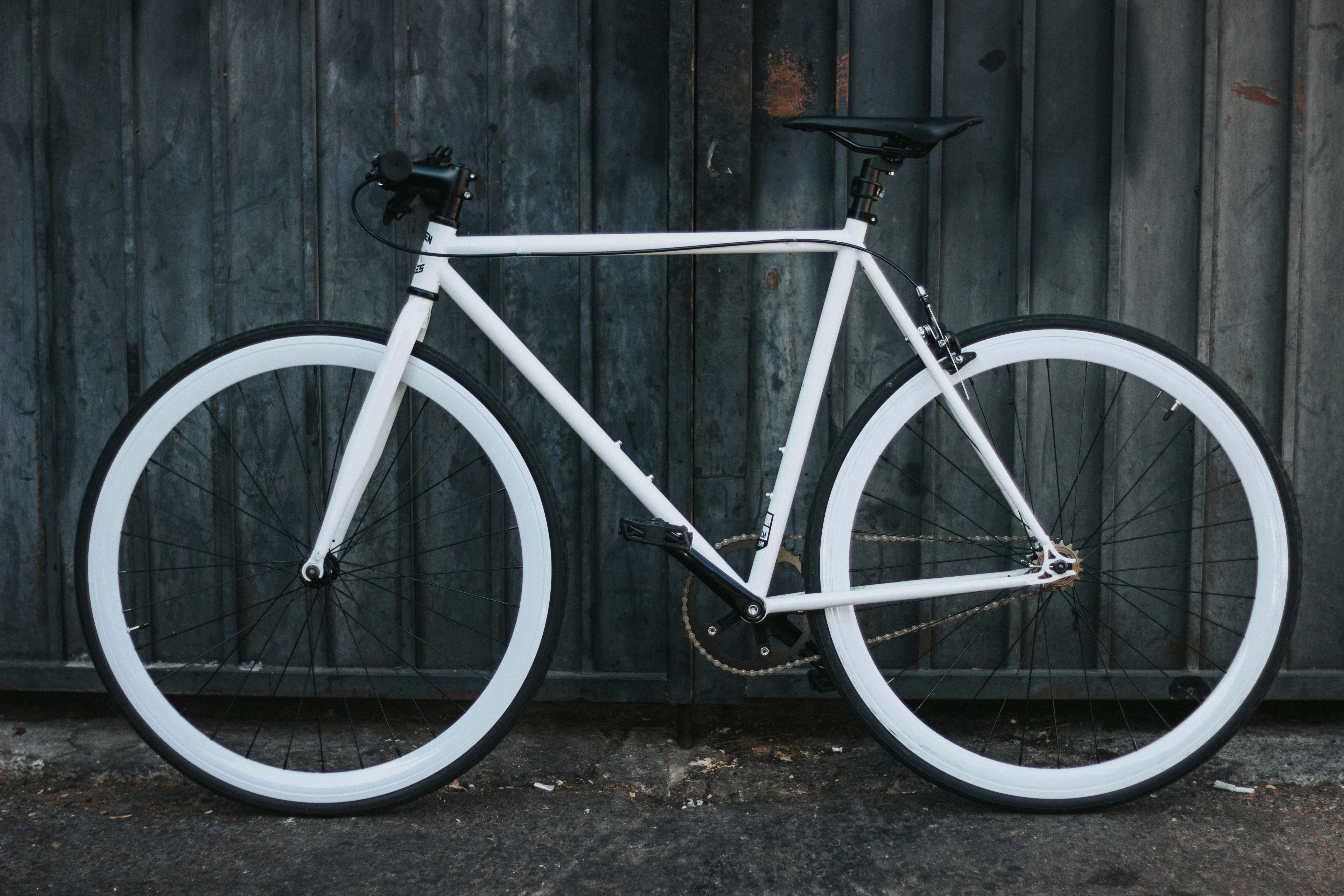 White road bicycle beside gray steel panel photo – Free Grey Image on ...