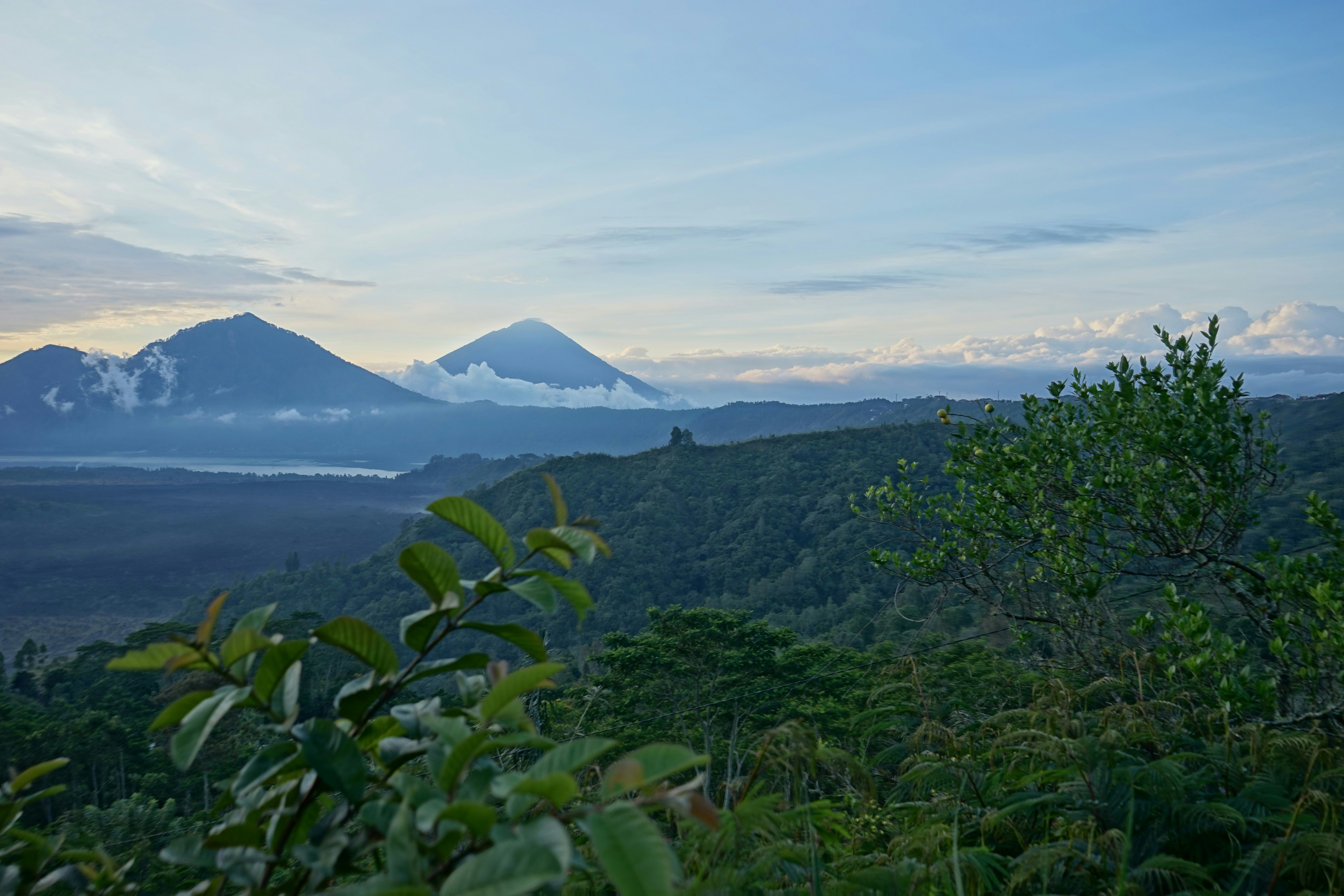 Twin Peaks Beneath a Misty Dawn Over Lush Highlands